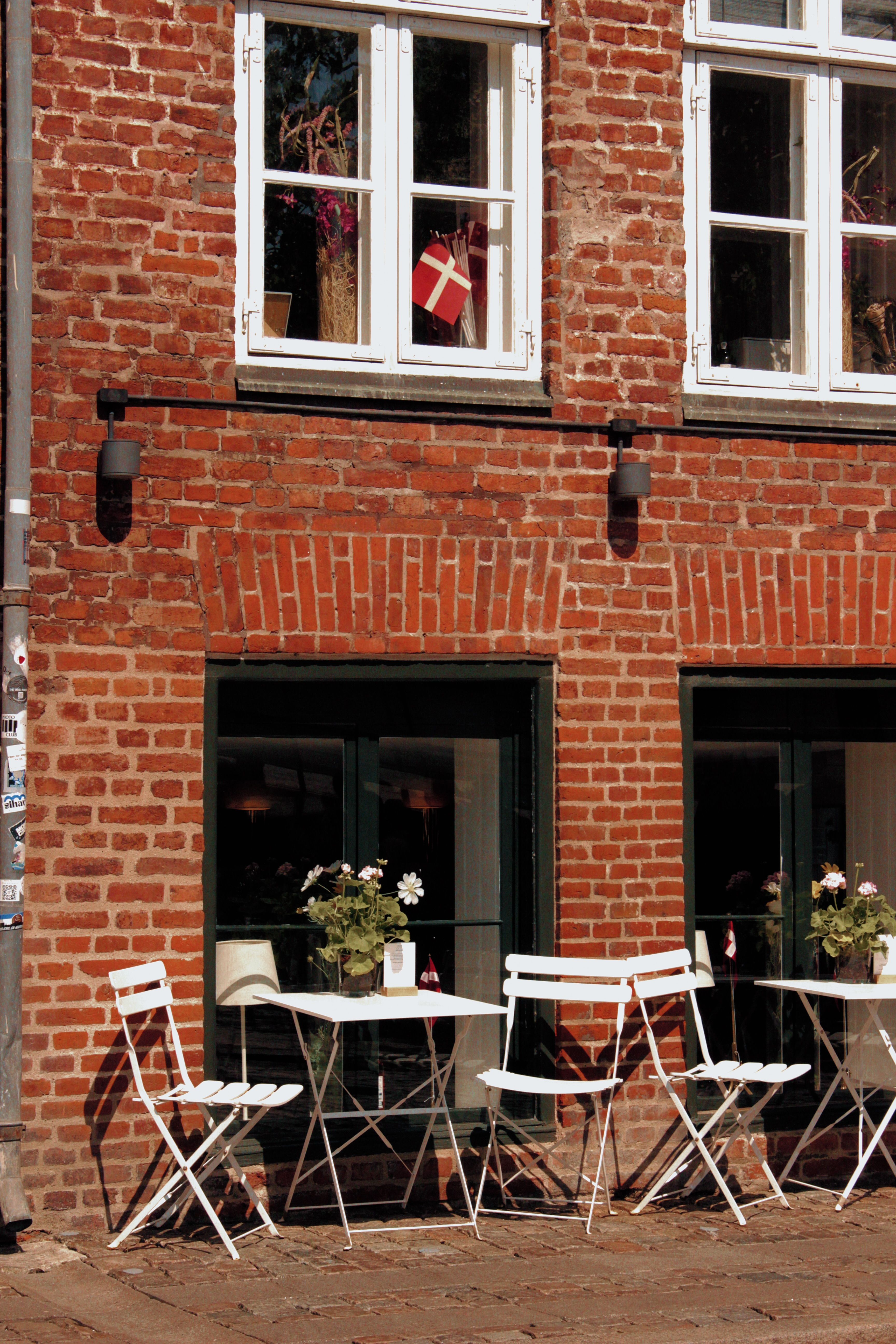 Charming Danish Café Scene with Red Brick Building · Free Stock Photo