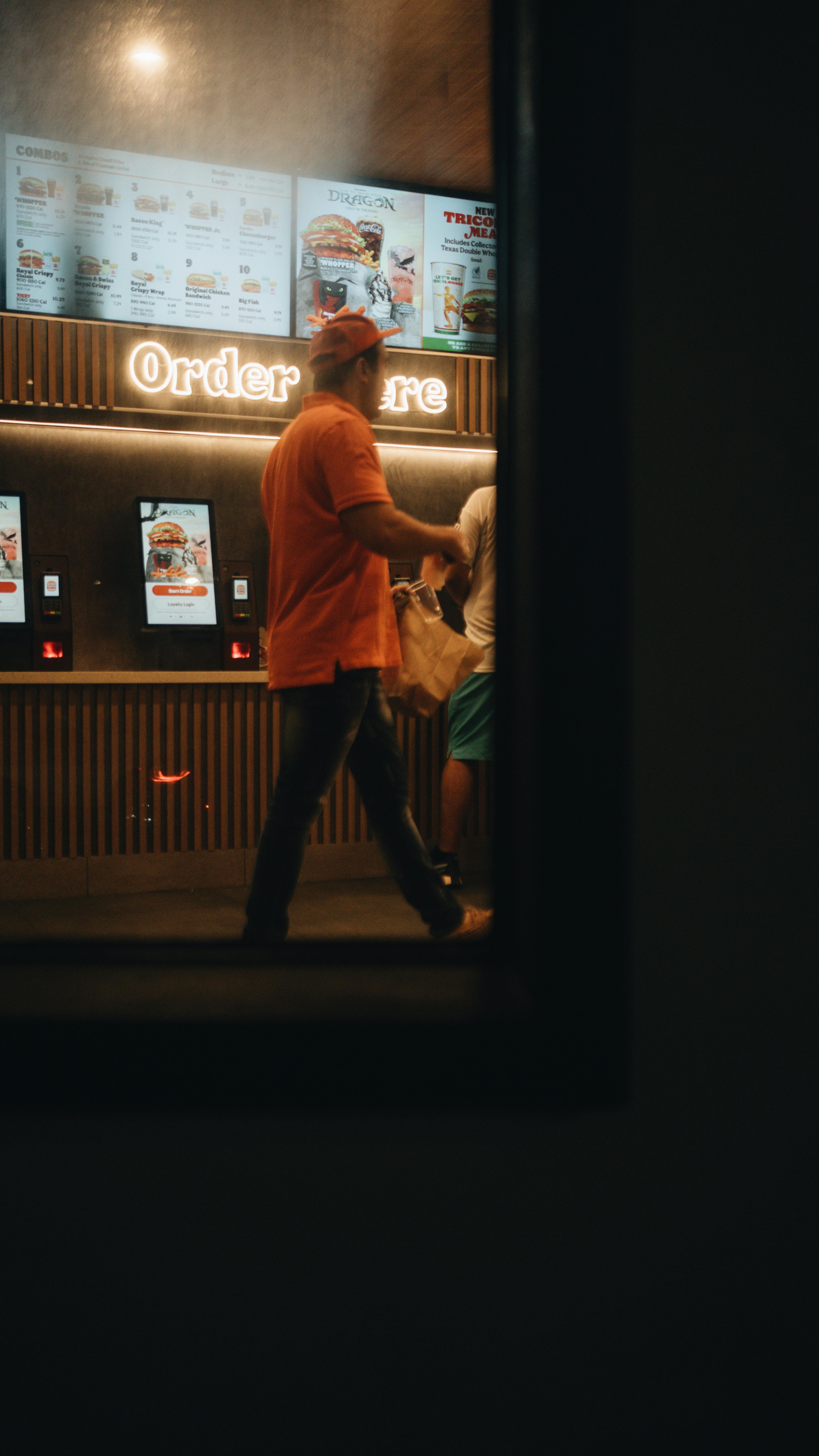 Fast Food Ordering Scene in Low Light · Free Stock Photo