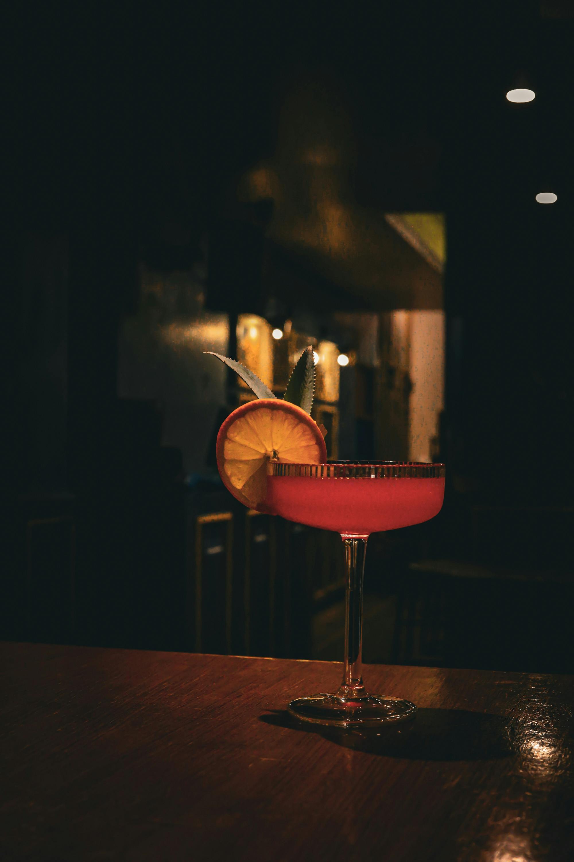 Elegant Cocktail with Citrus Garnish in Dim Bar · Free Stock Photo