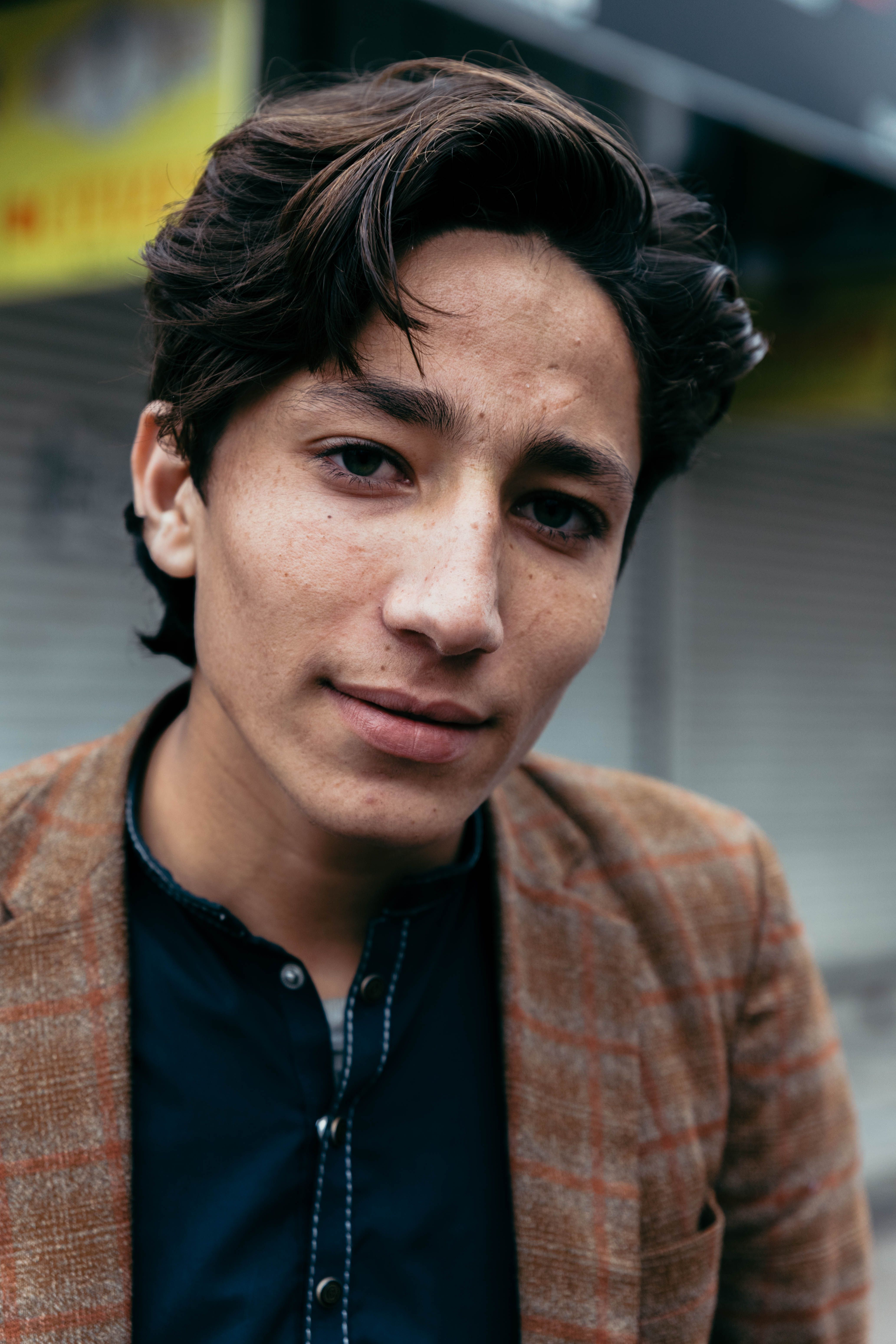 Young Man in Stylish Jacket on Urban Street · Free Stock Photo