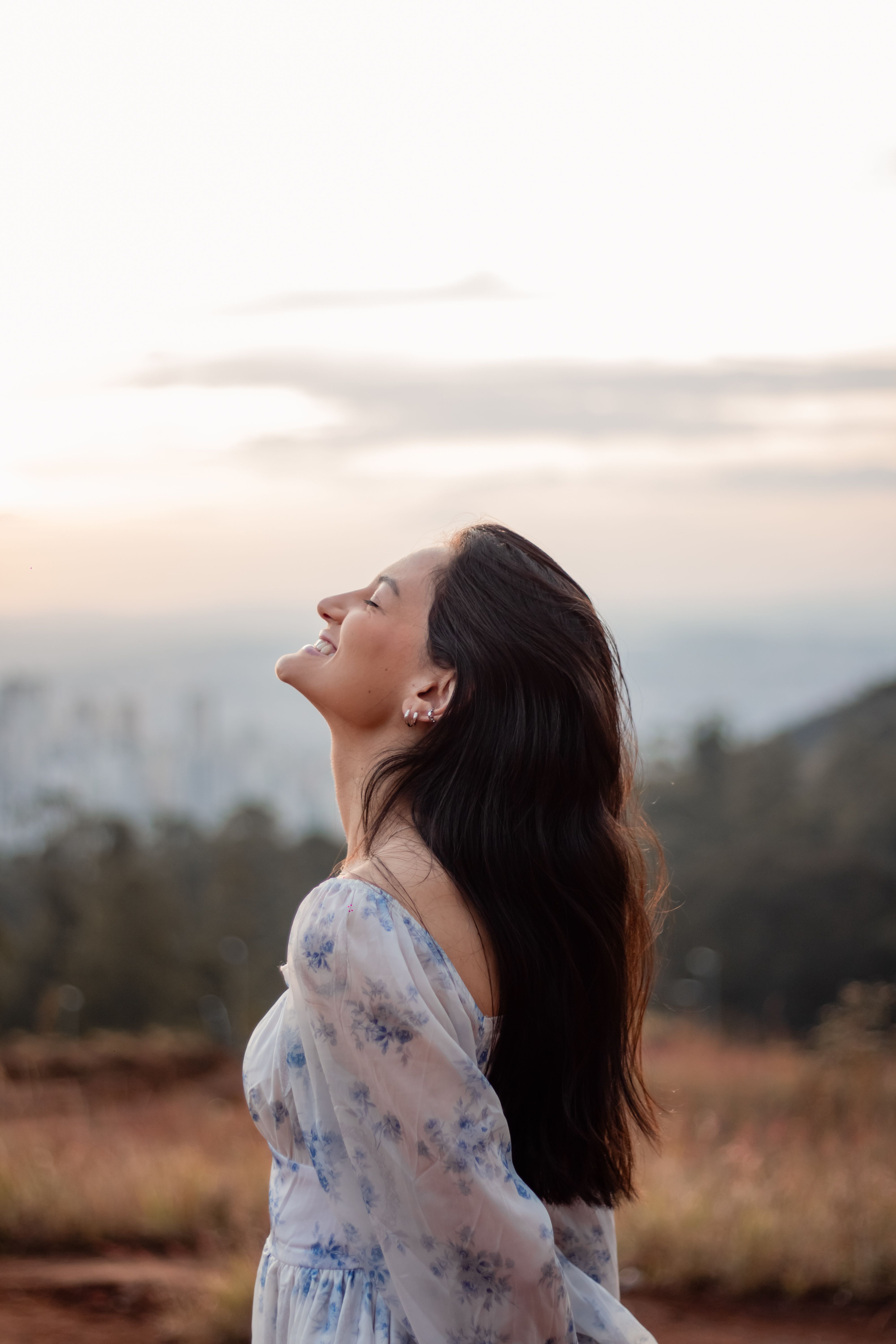 Profile of a Woman Relaxing Outdoors at Sunset · Free Stock Photo