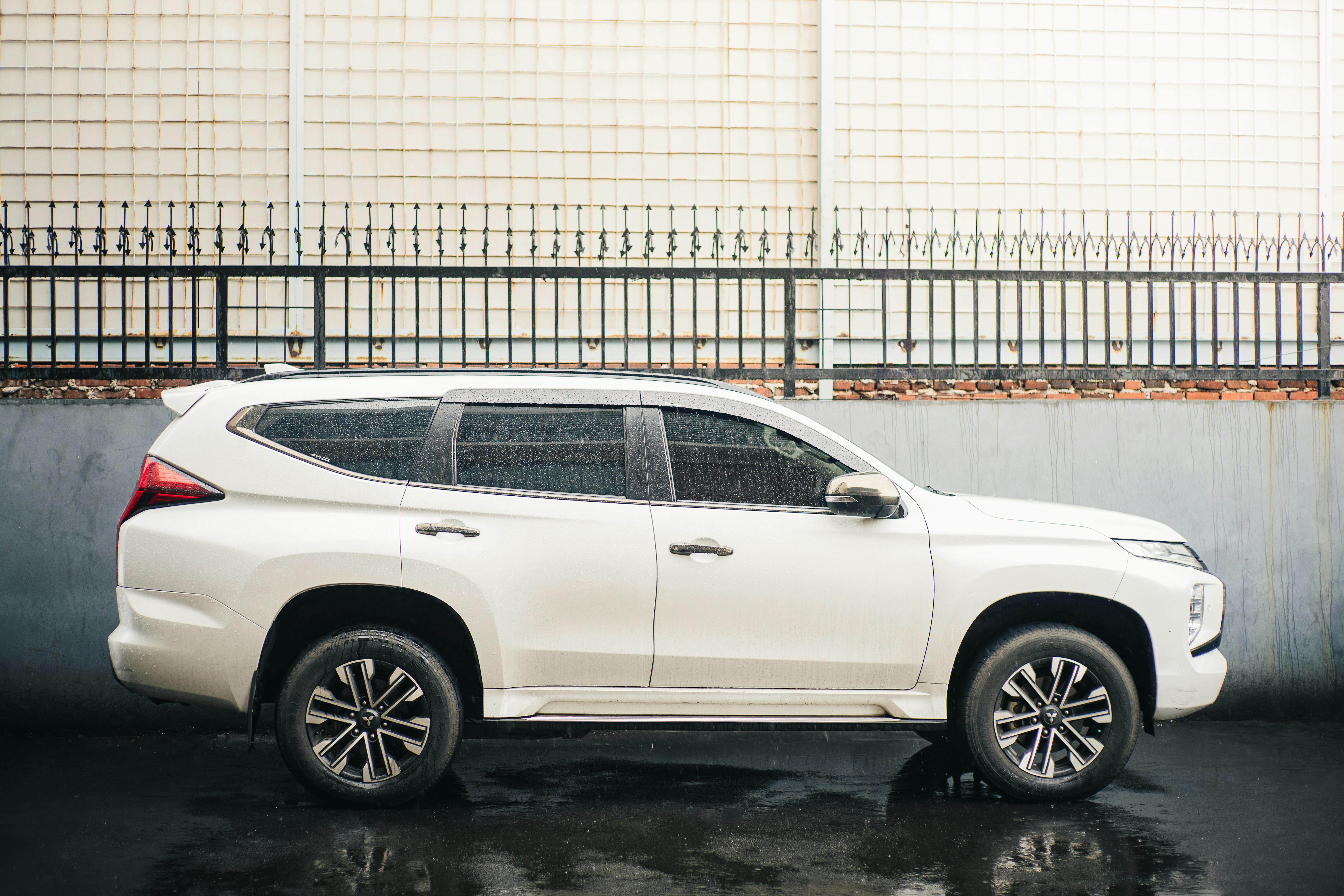 White SUV Parked in Urban Setting Side View · Free Stock Photo