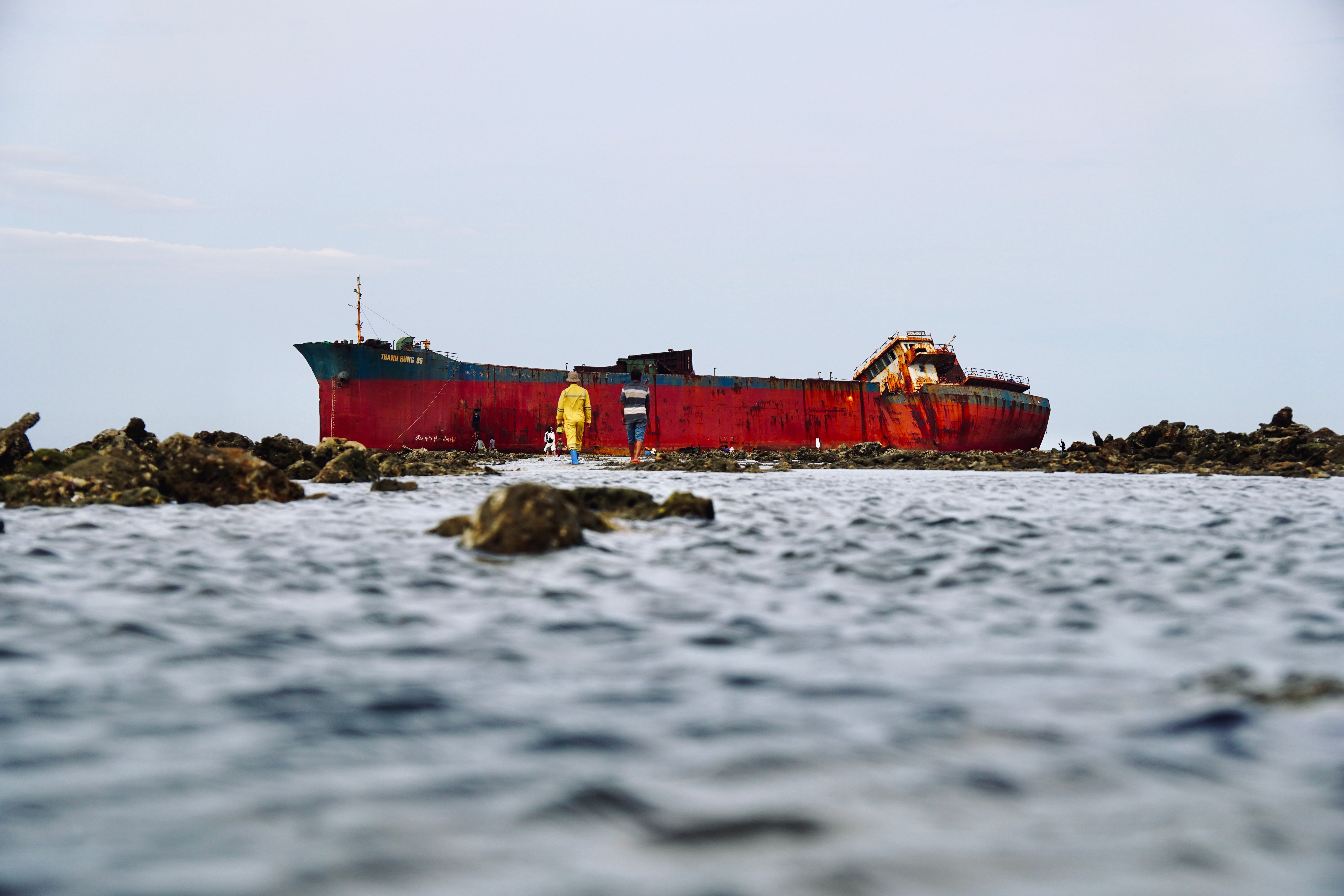 Sunken Ship and People Exploring at Low Tide · Free Stock Photo