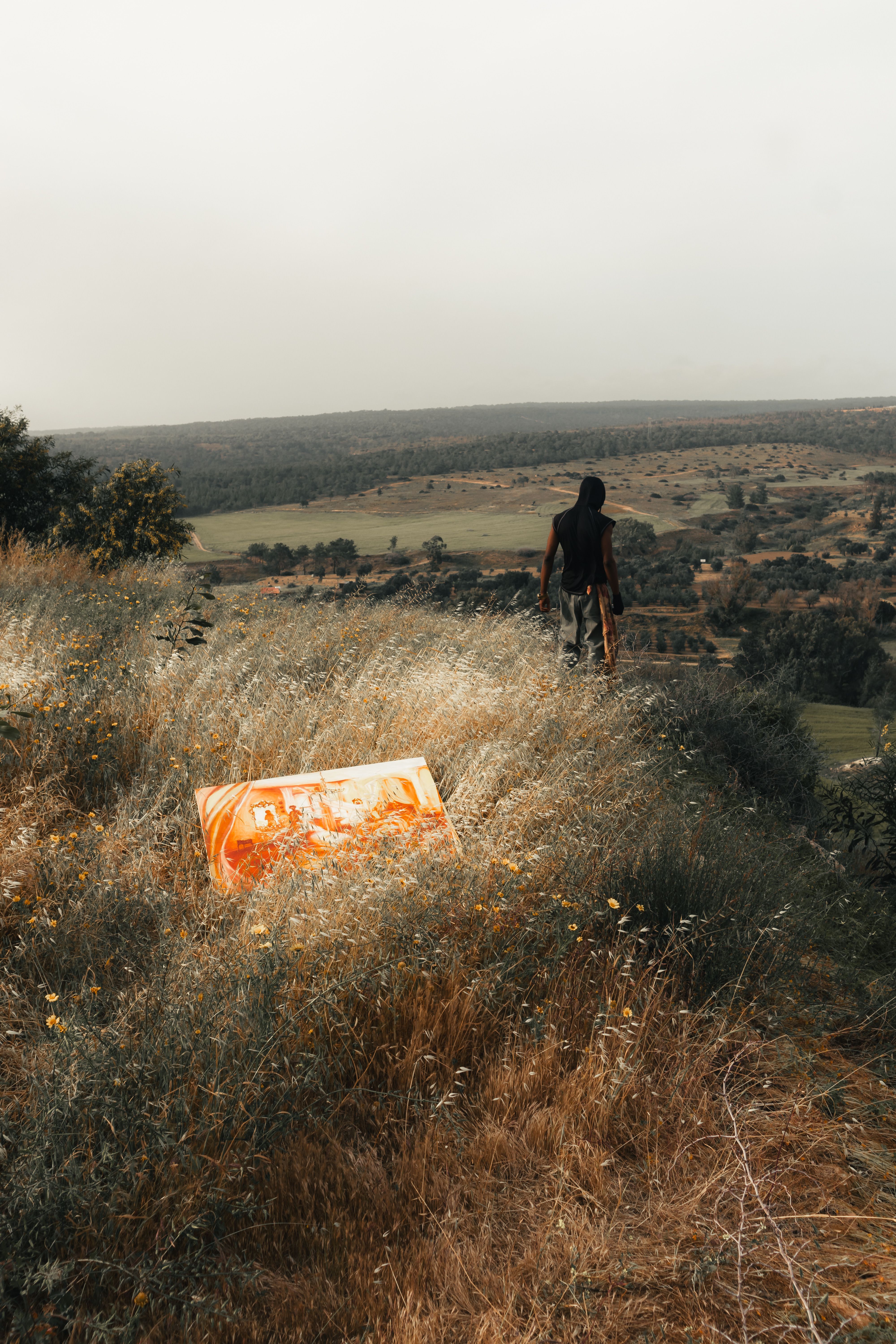 Lone Figure on a Hillside with Distant Horizon · Free Stock Photo