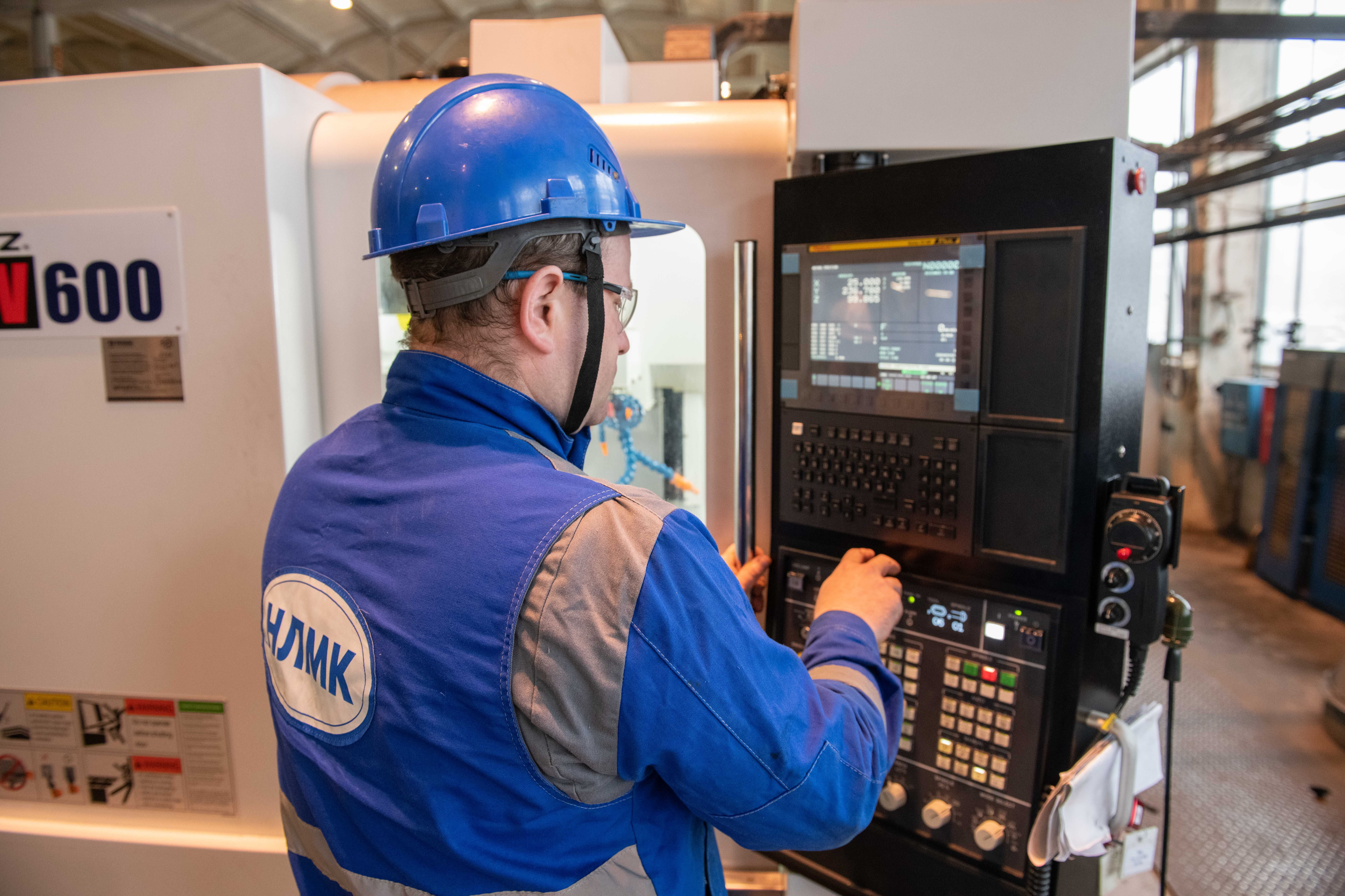 Worker Operating CNC Machine in Russian Factory · Free Stock Photo