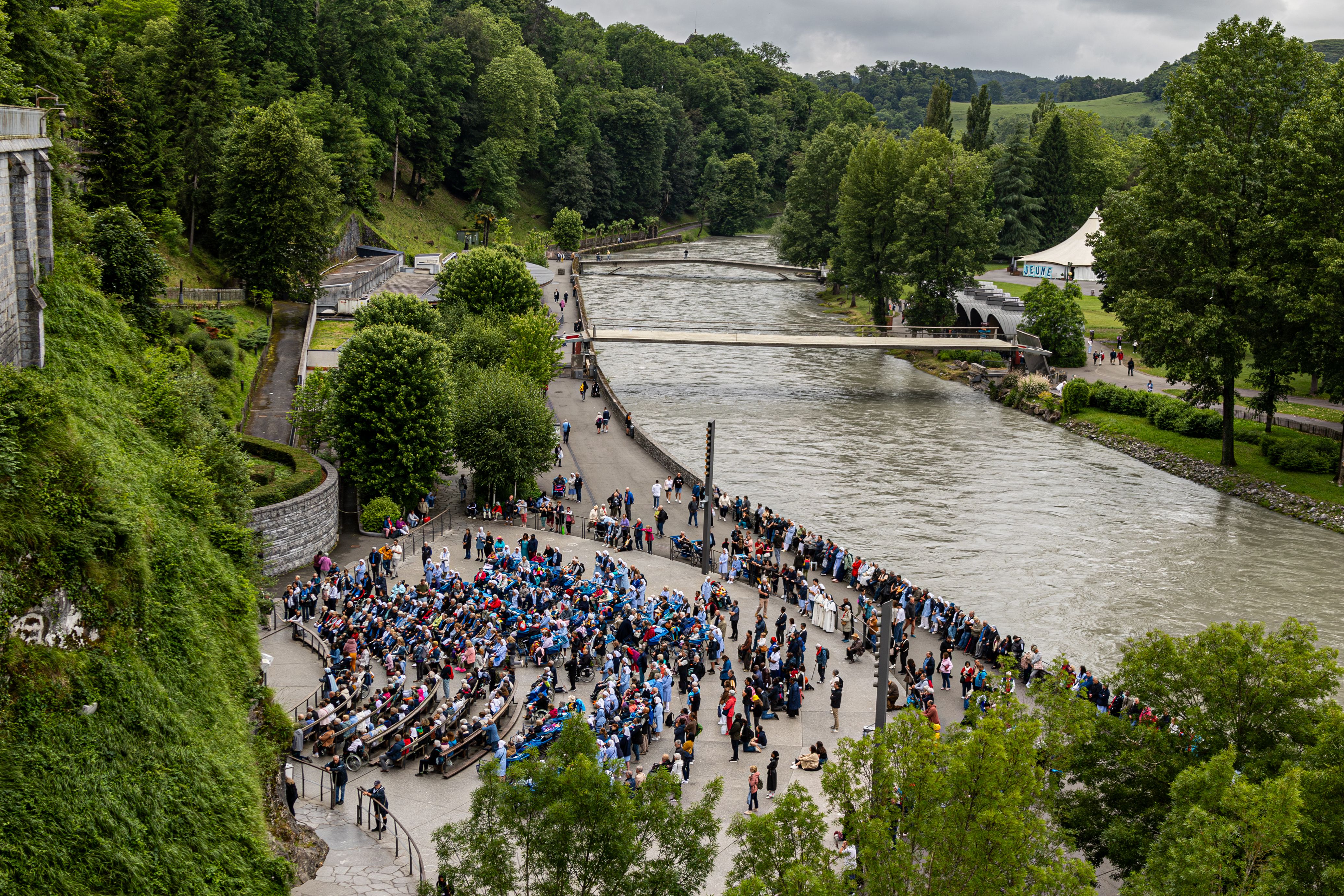 Crowd Gathering by Riverside Park Scenic View · Free Stock Photo