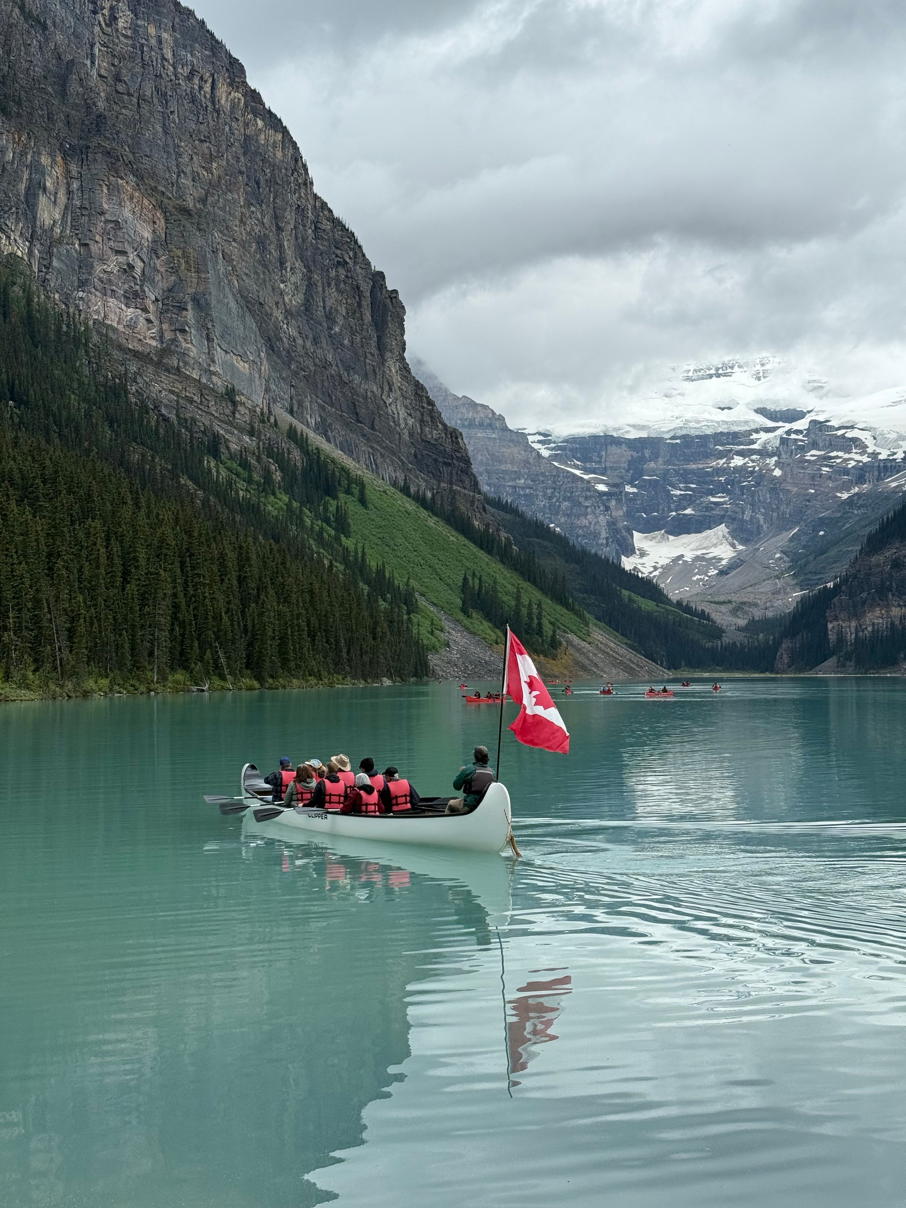 Canoeing on Lake Louise with Canadian Flag · Free Stock Photo