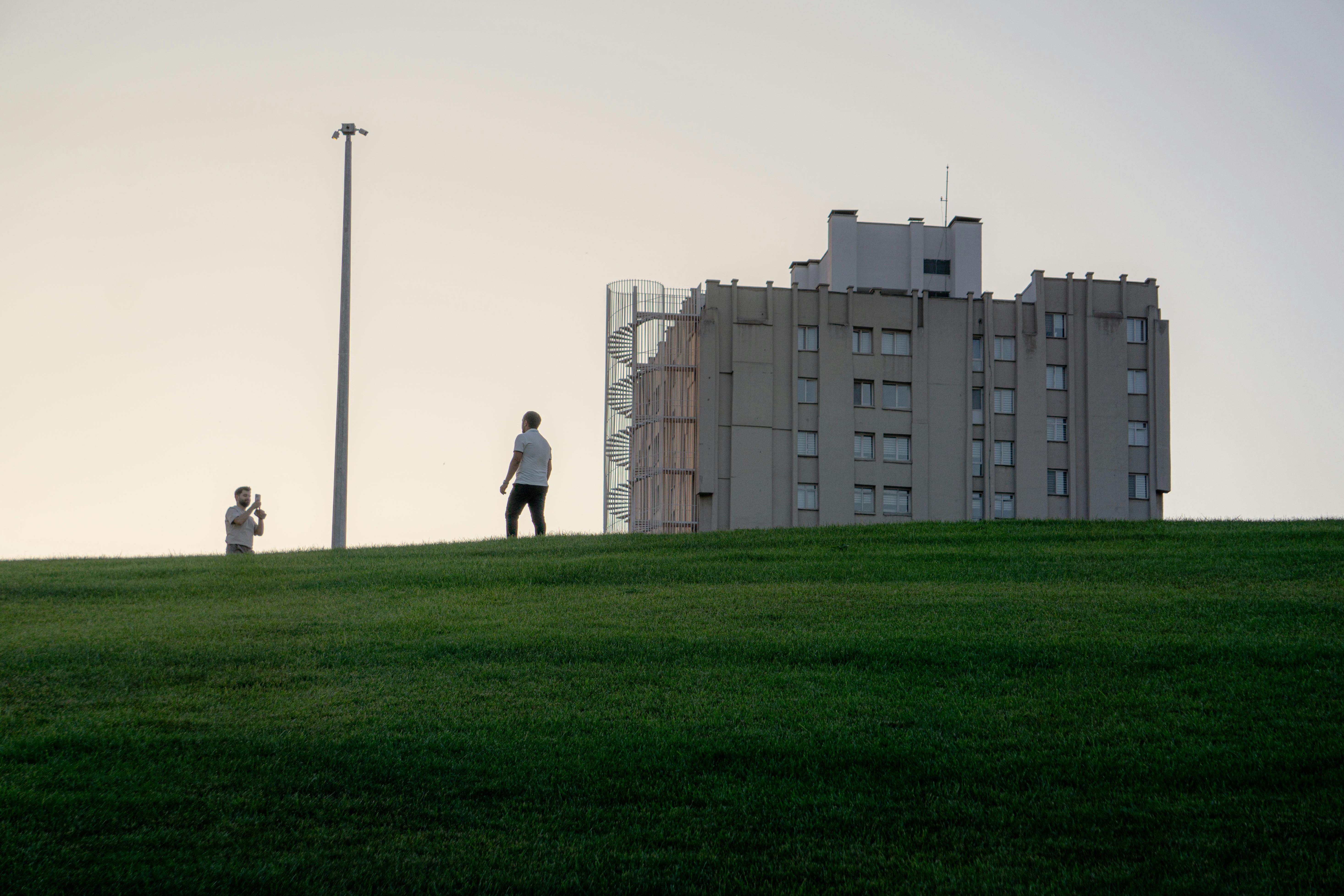 Urban Scene with Green Field and Building · Free Stock Photo