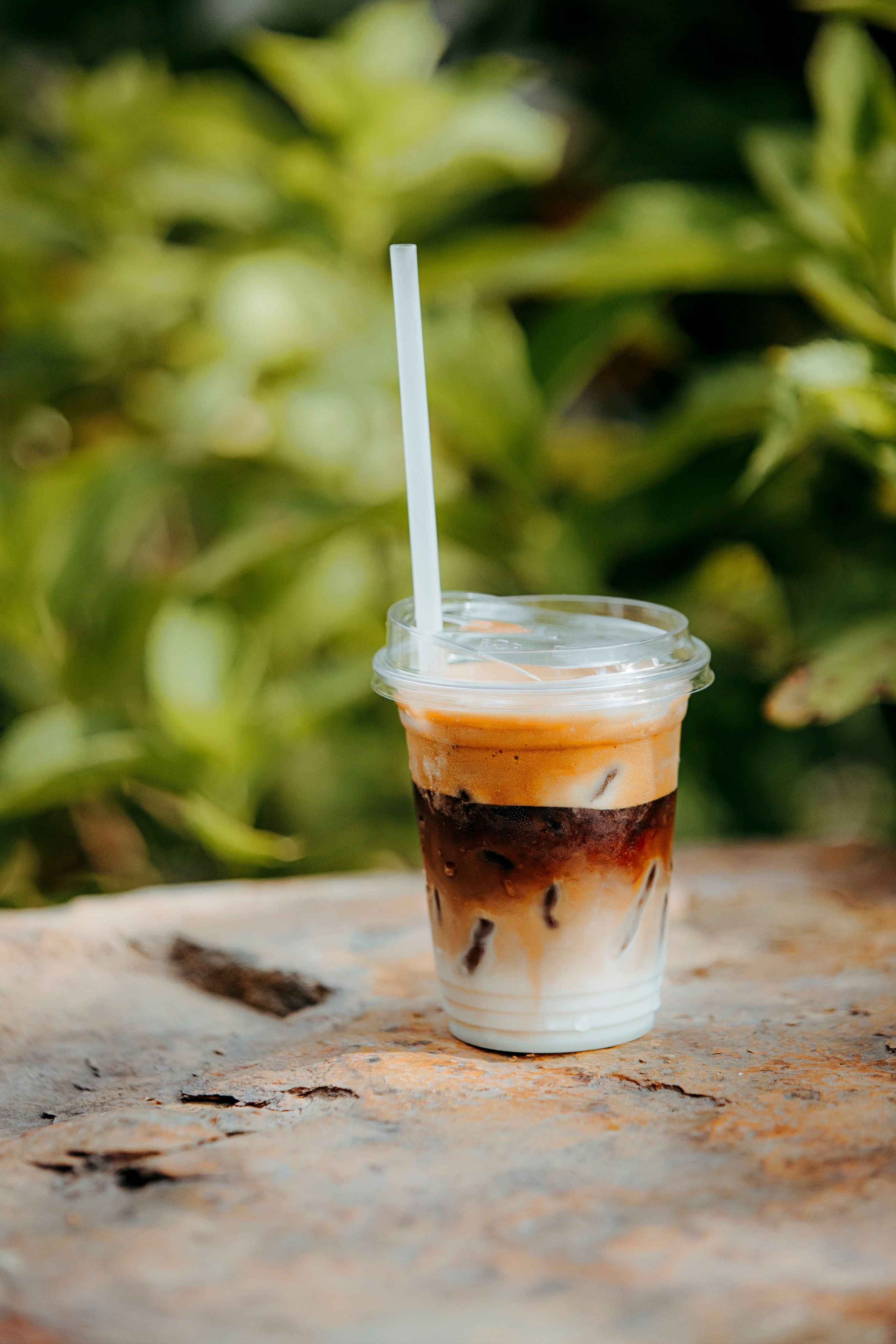 Cold Brew Coffee with Straw on Rustic Table · Free Stock Photo