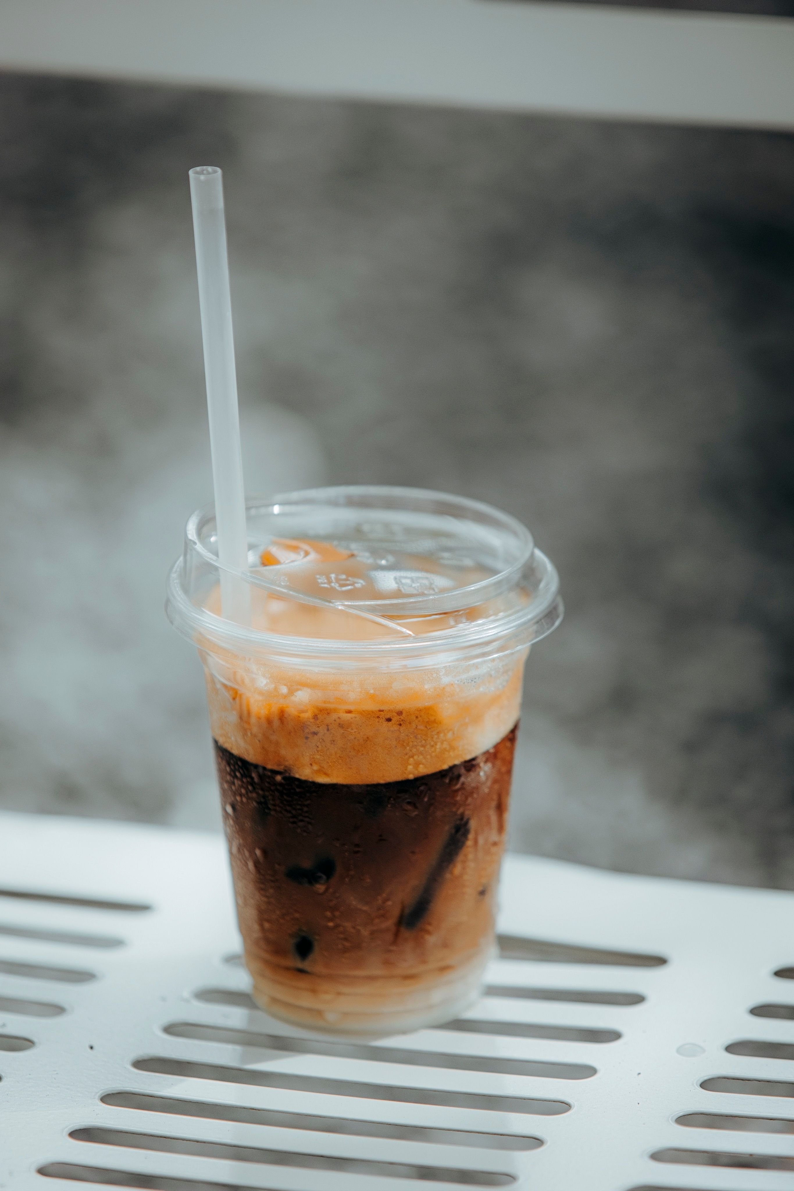 Refreshing Iced Coffee With Cream in Plastic Cup · Free Stock Photo
