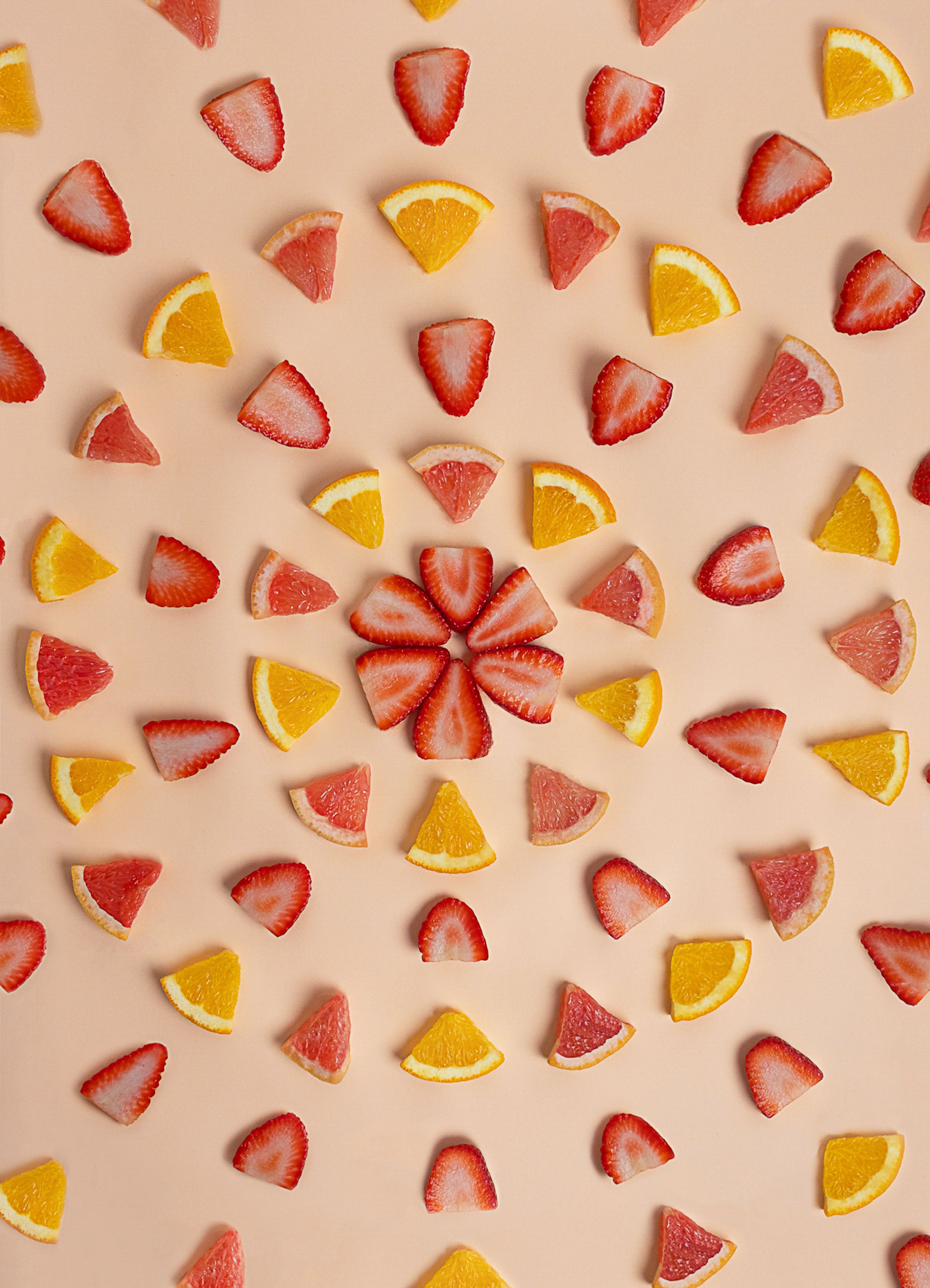 Colorful Sliced Fruit Arrangement on Beige Background · Free Stock Photo