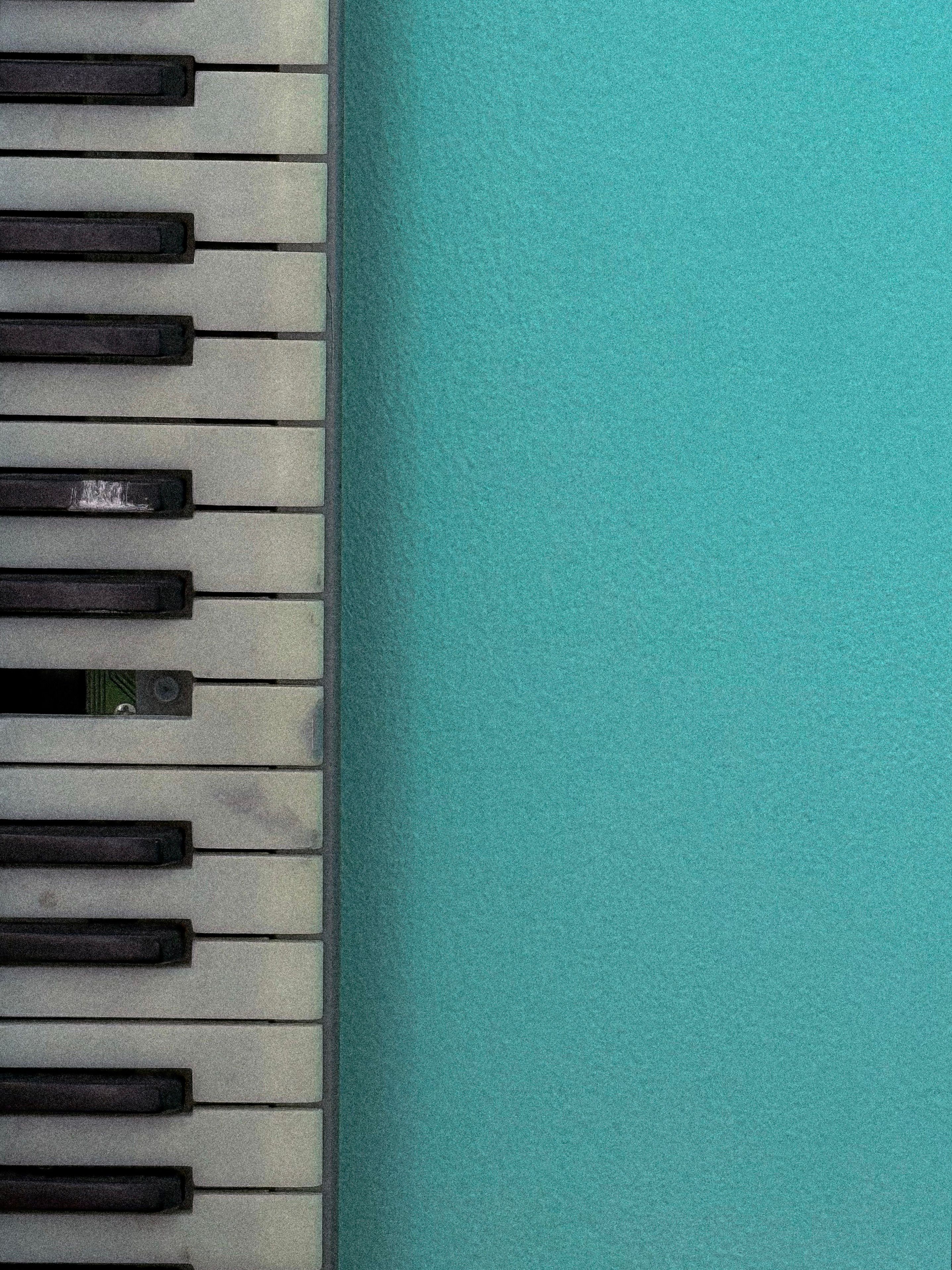 Minimalist Keyboard Against Turquoise Wall · Free Stock Photo