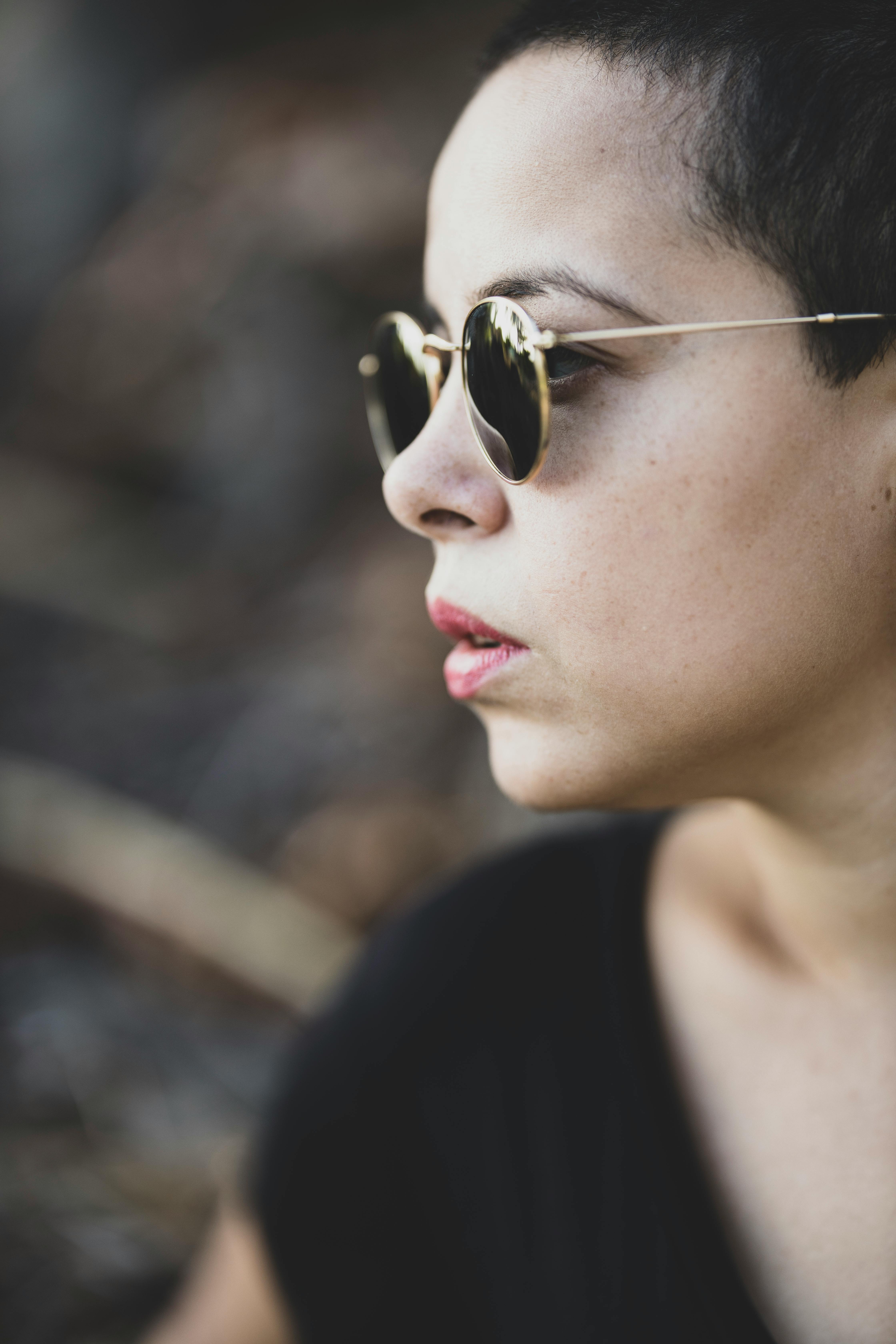 Shallow Focus Photo of Person Wearing Black Sunglasses · Free Stock Photo