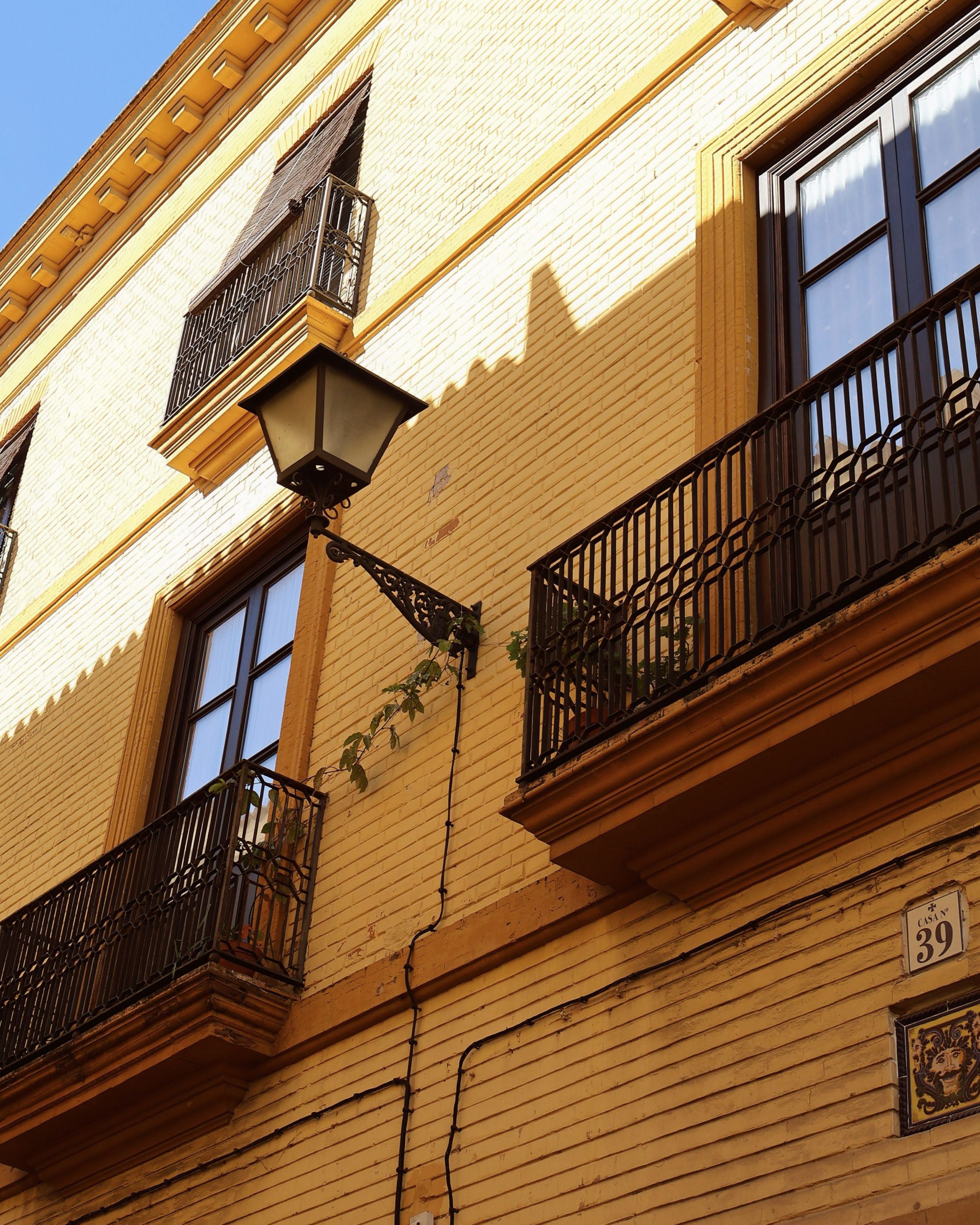 Warm Yellow Brick Building with Iron Balconies · Free Stock Photo