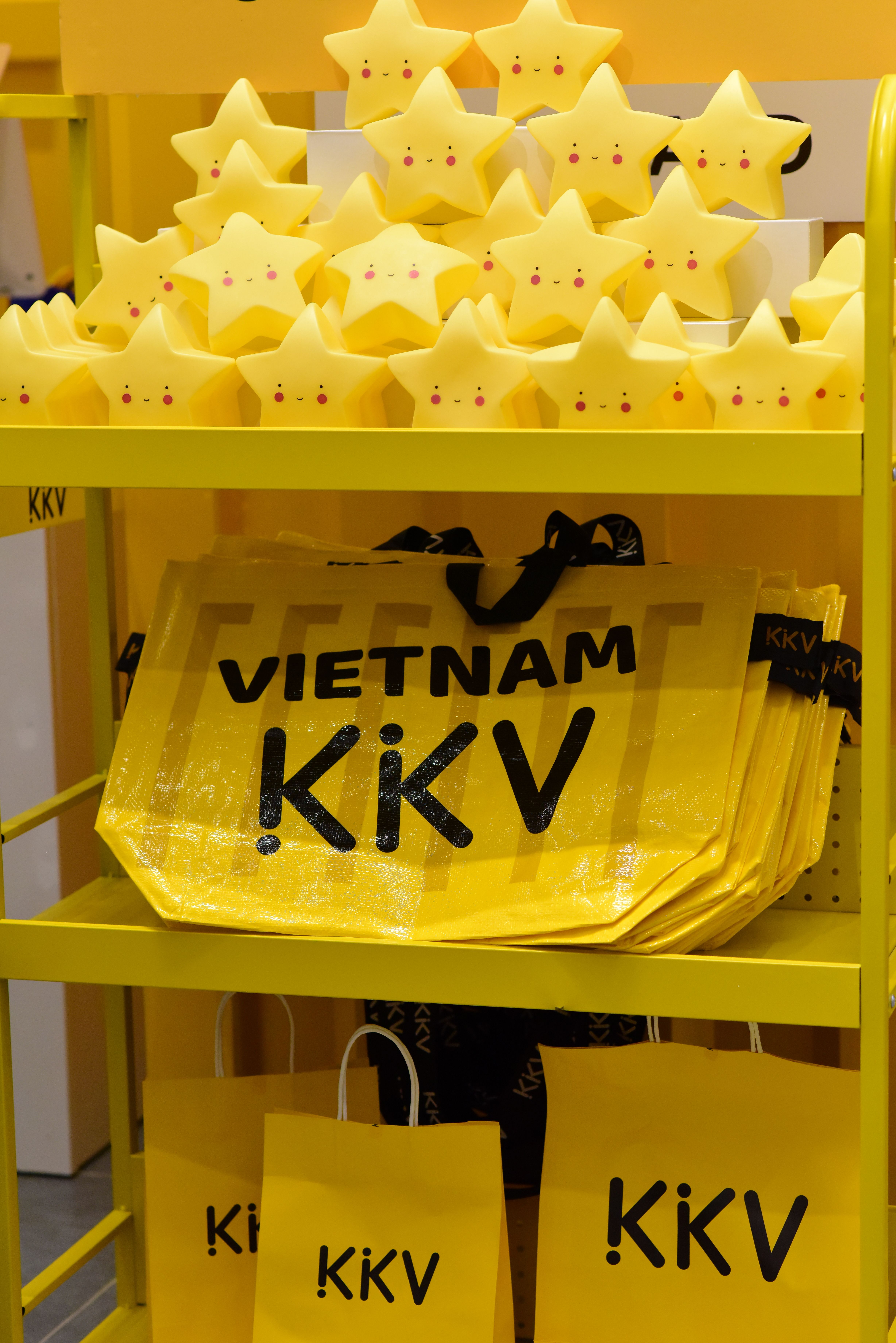 Vibrant Yellow Star Toys and Shopping Bags Display · Free Stock Photo