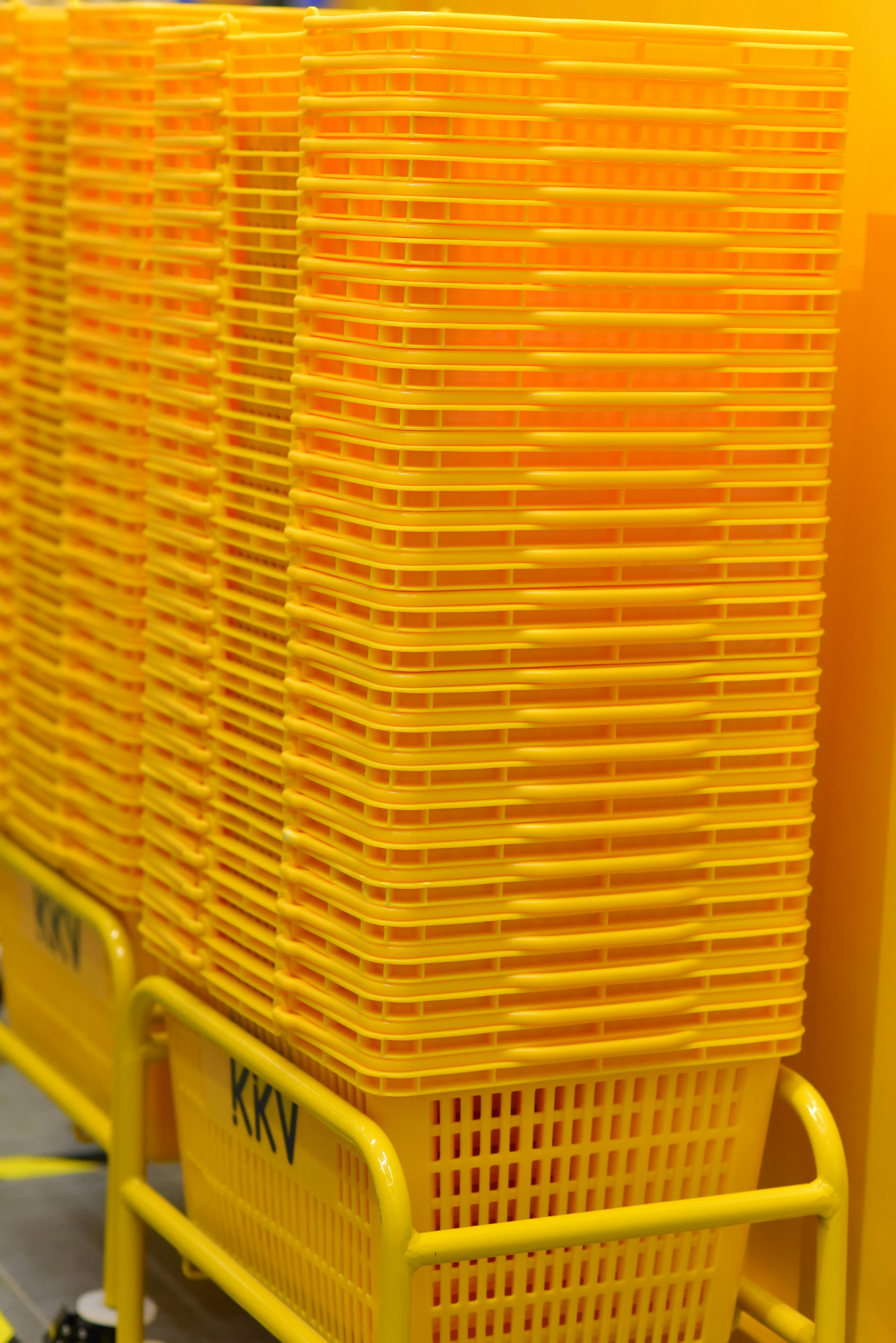 Stack of Vibrant Yellow Shopping Baskets · Free Stock Photo