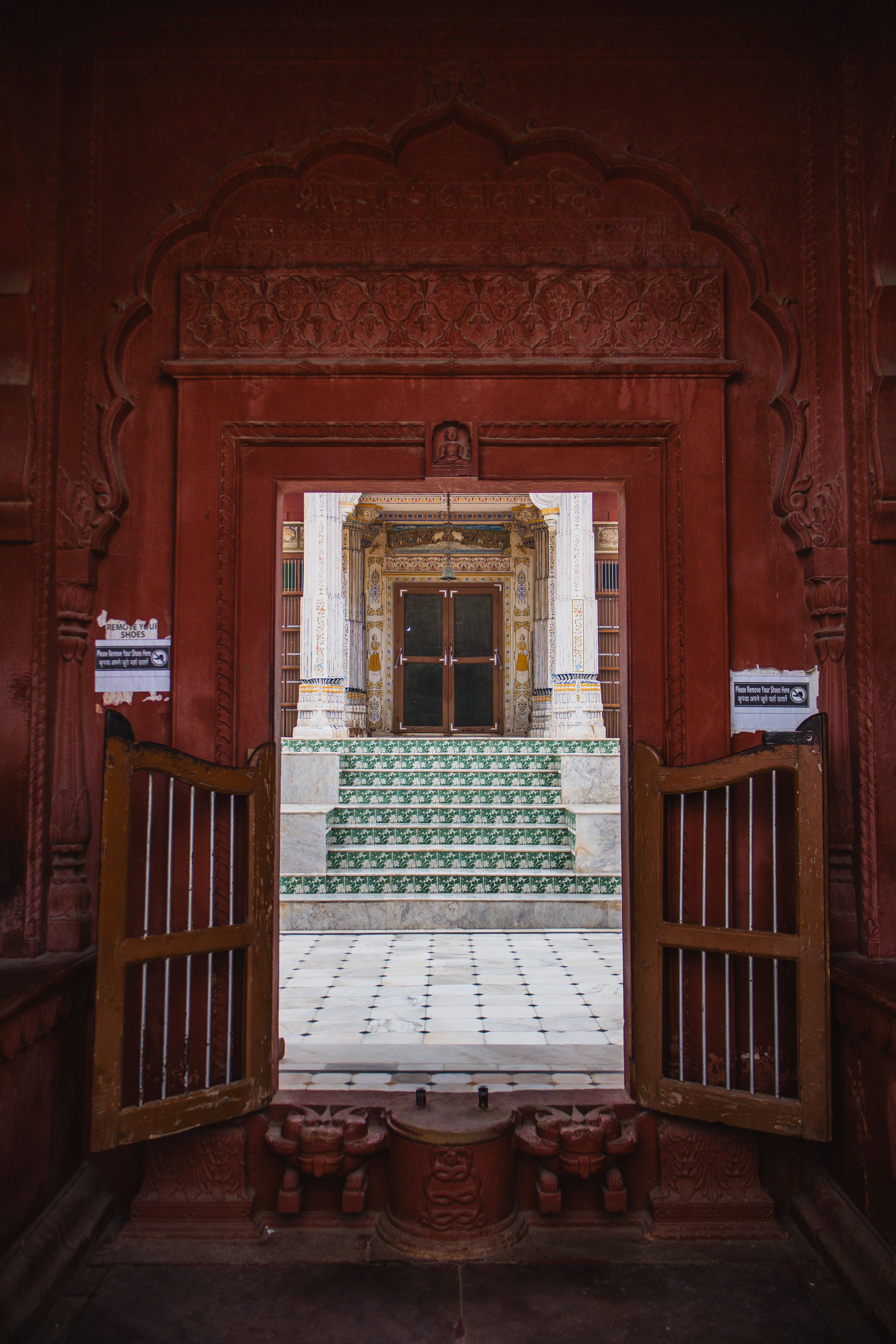 Intricate Red Archway with Open Wooden Doors · Free Stock Photo
