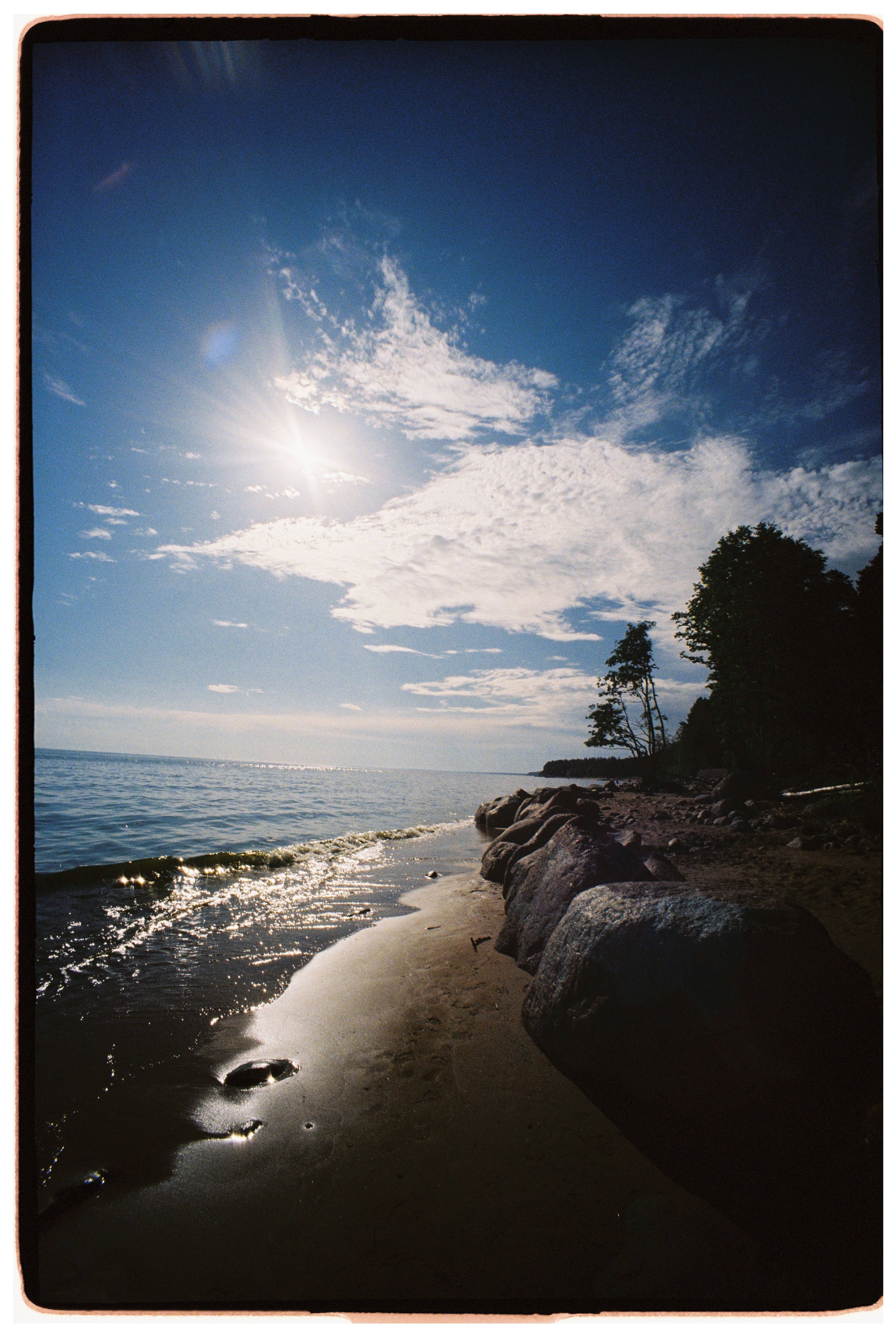 Serene Beach Landscape with Bright Sunlight · Free Stock Photo