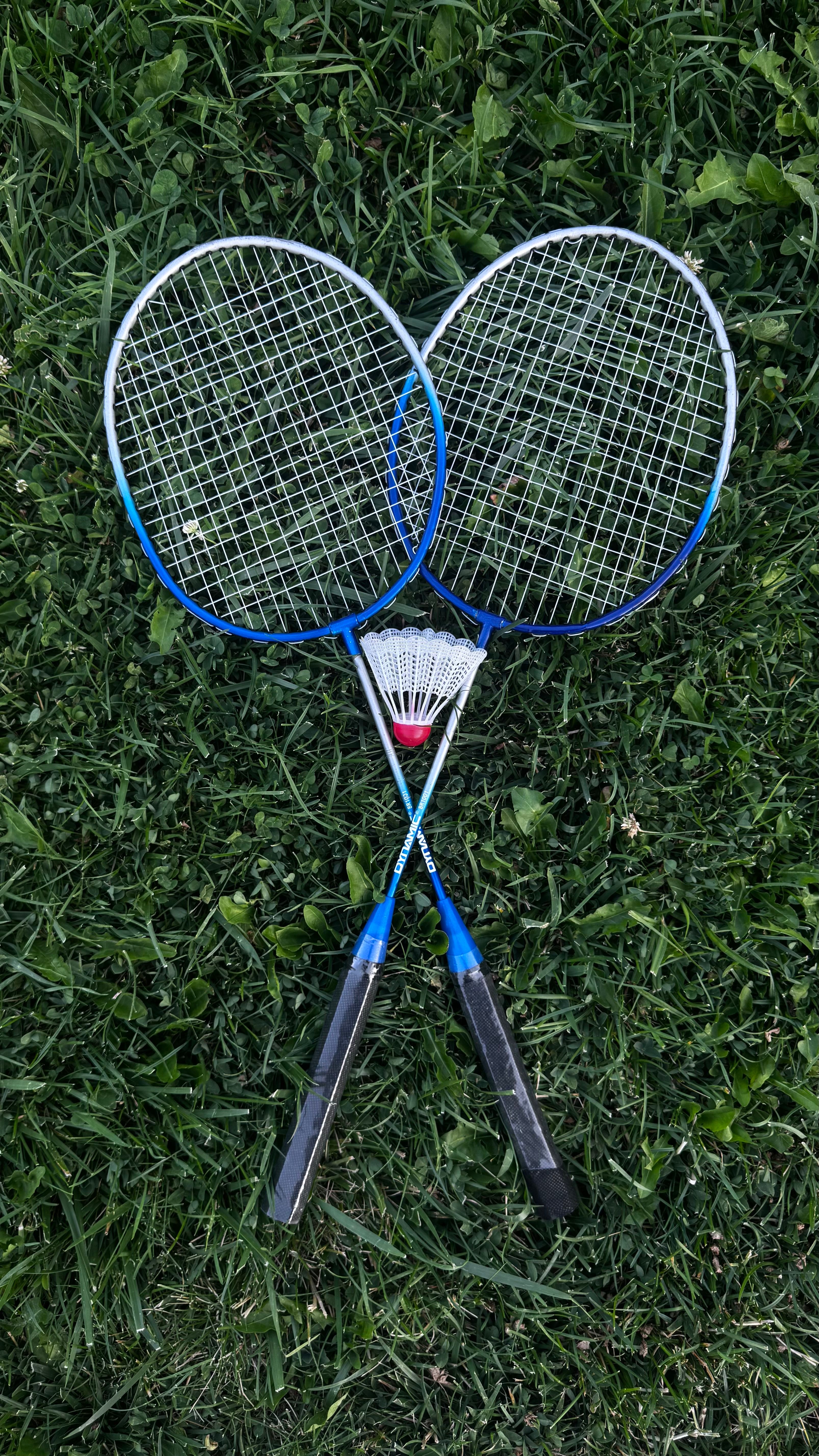 Pair of Badminton Rackets on Grass Surface · Free Stock Photo