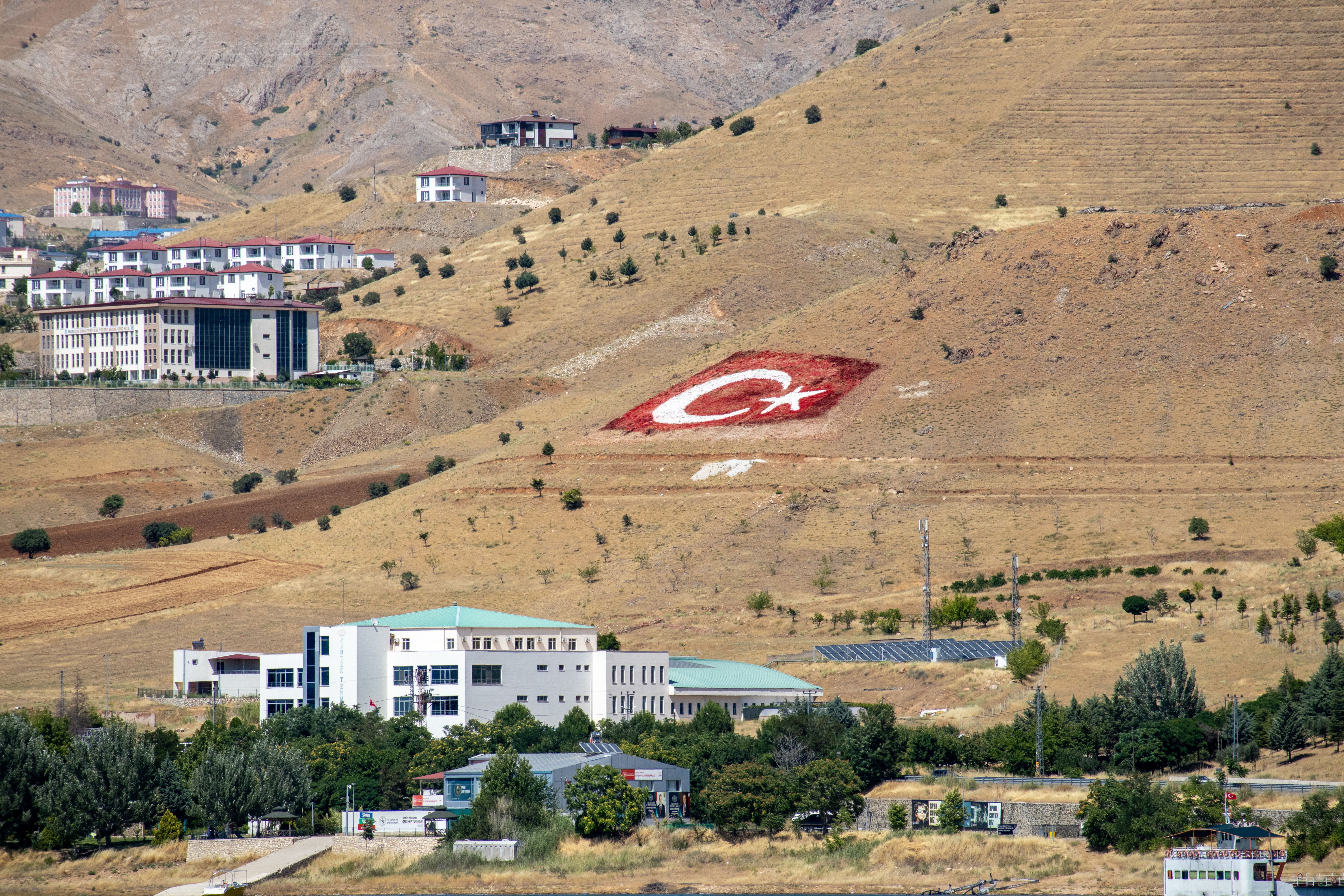 Scenic View of Pertek with Turkish Flag on Hillside · Free Stock Photo