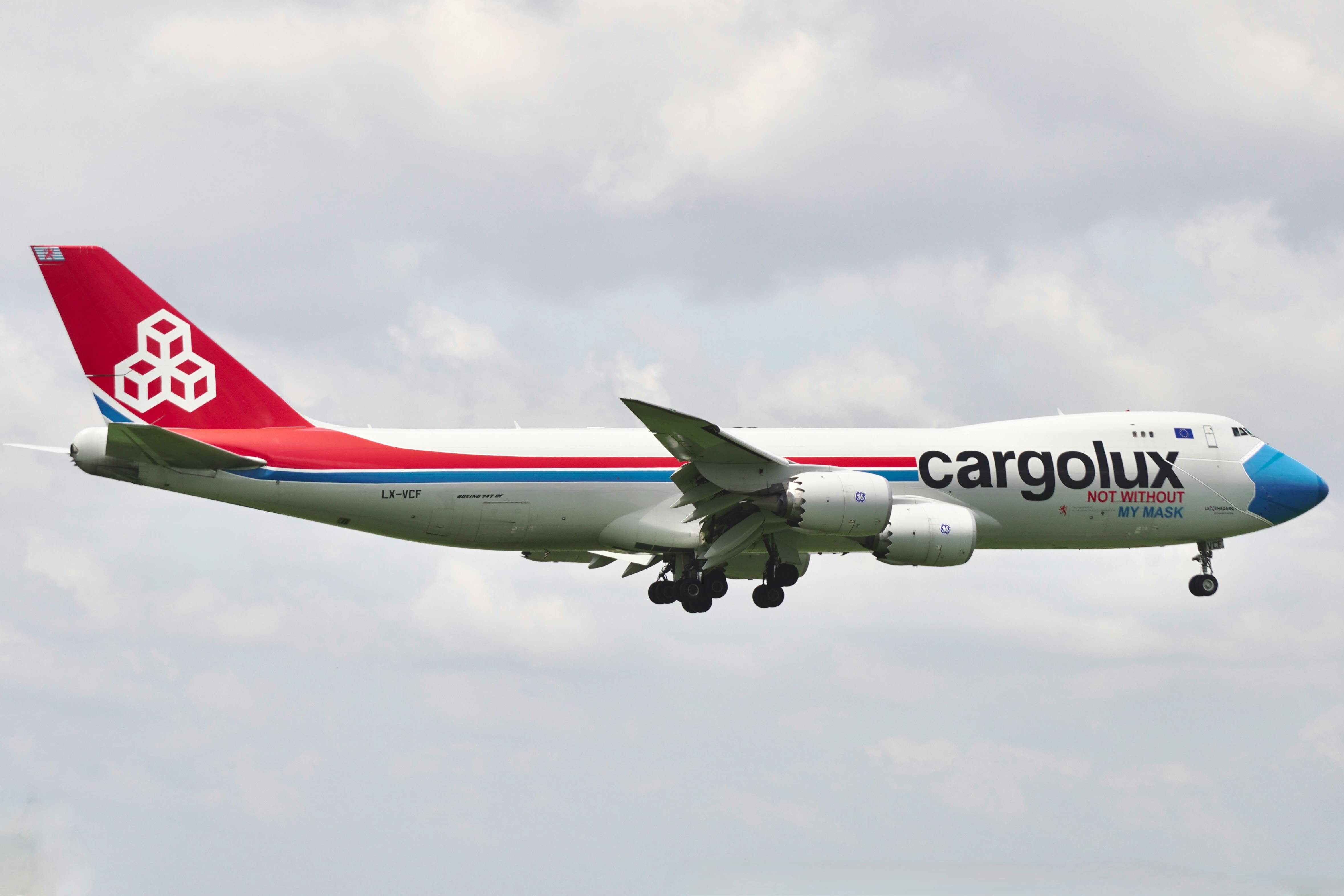 Cargolux Aircraft in Flight with Overcast Sky · Free Stock Photo