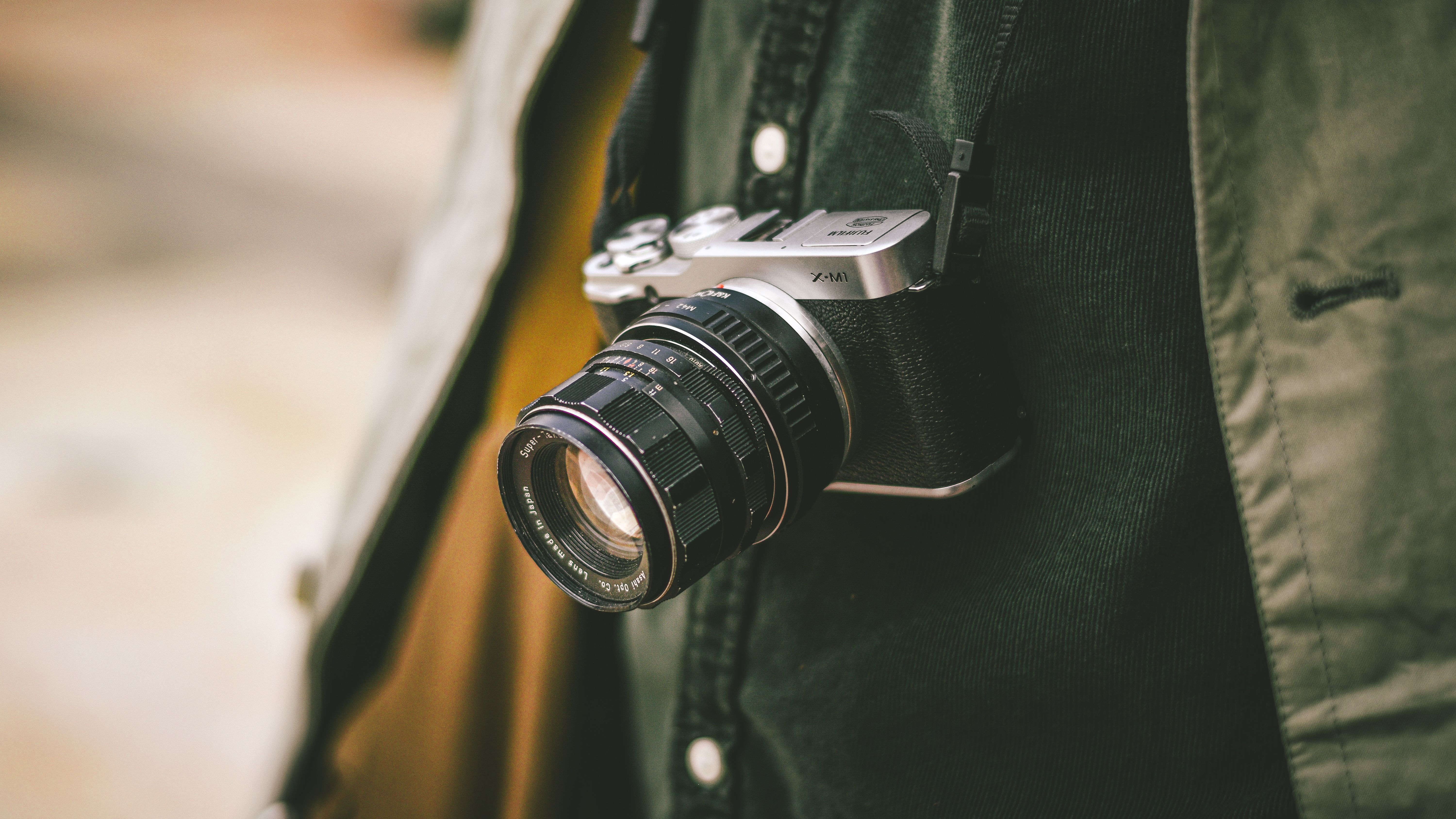 Shallow Photo of Person Holding Black Canon Dslr Camera · Free Stock Photo