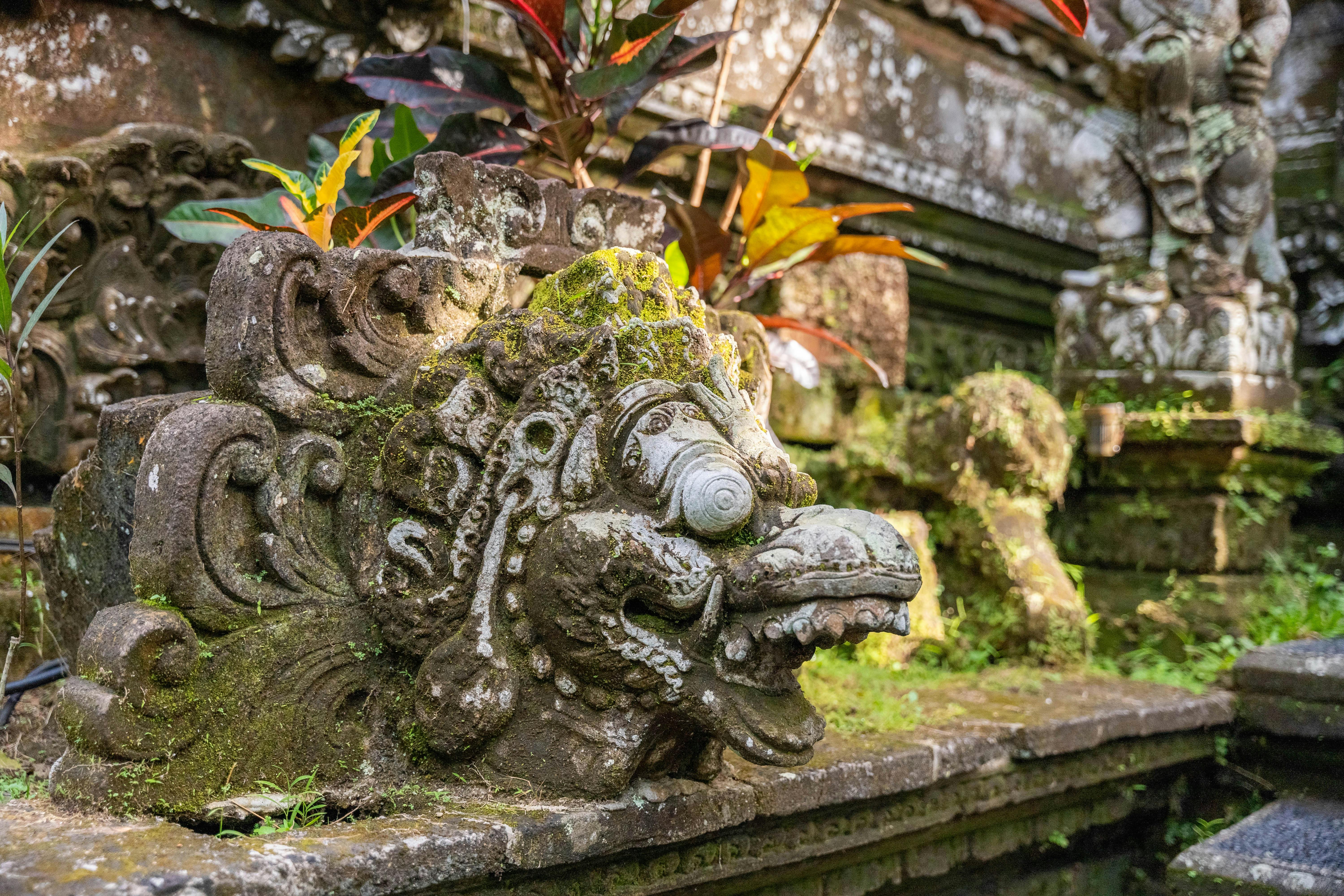 Intricate Balinese Stone Carving in Lush Garden · Free Stock Photo