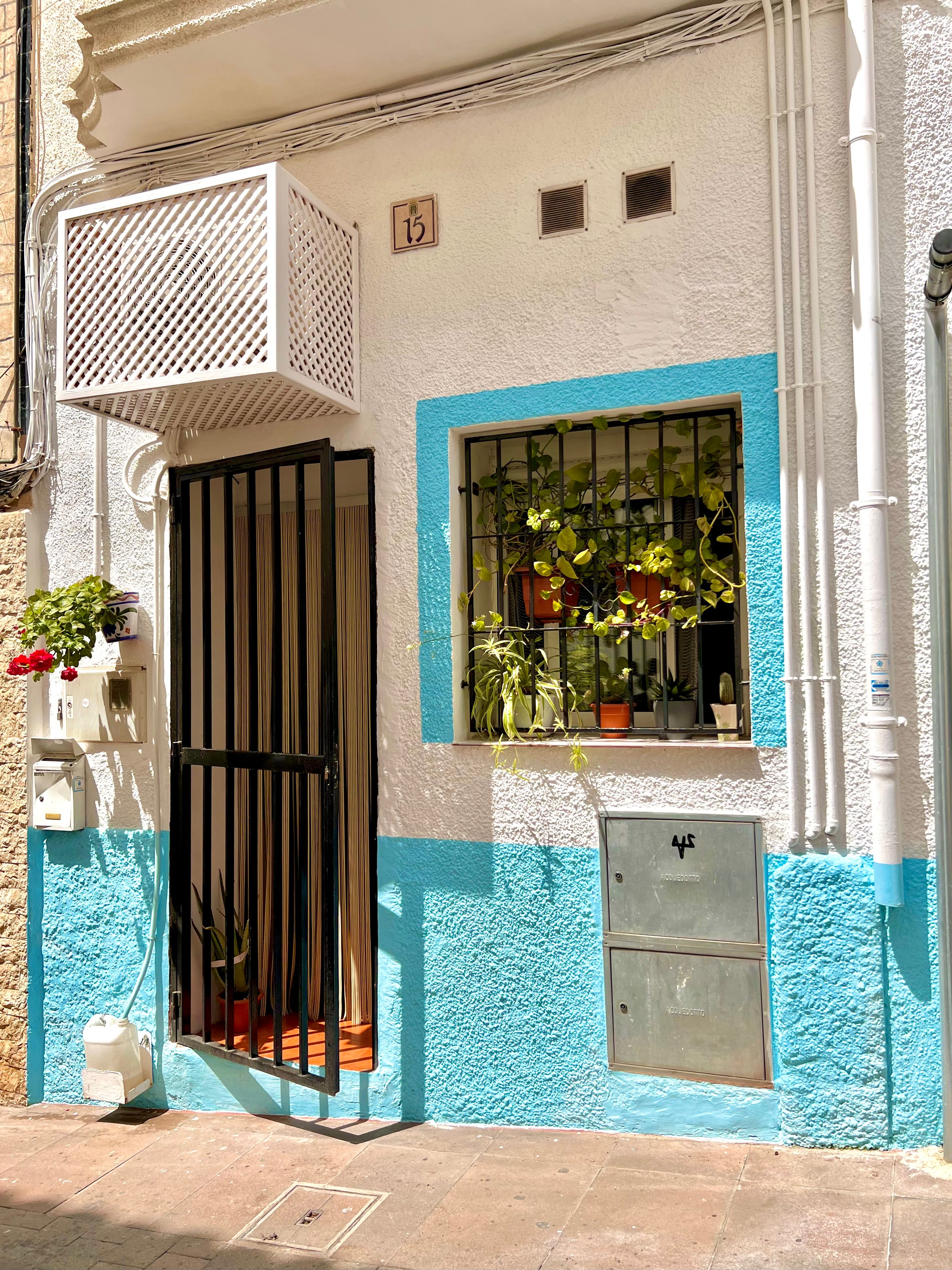 Charming Spanish House Facade with Blue Accents · Free Stock Photo