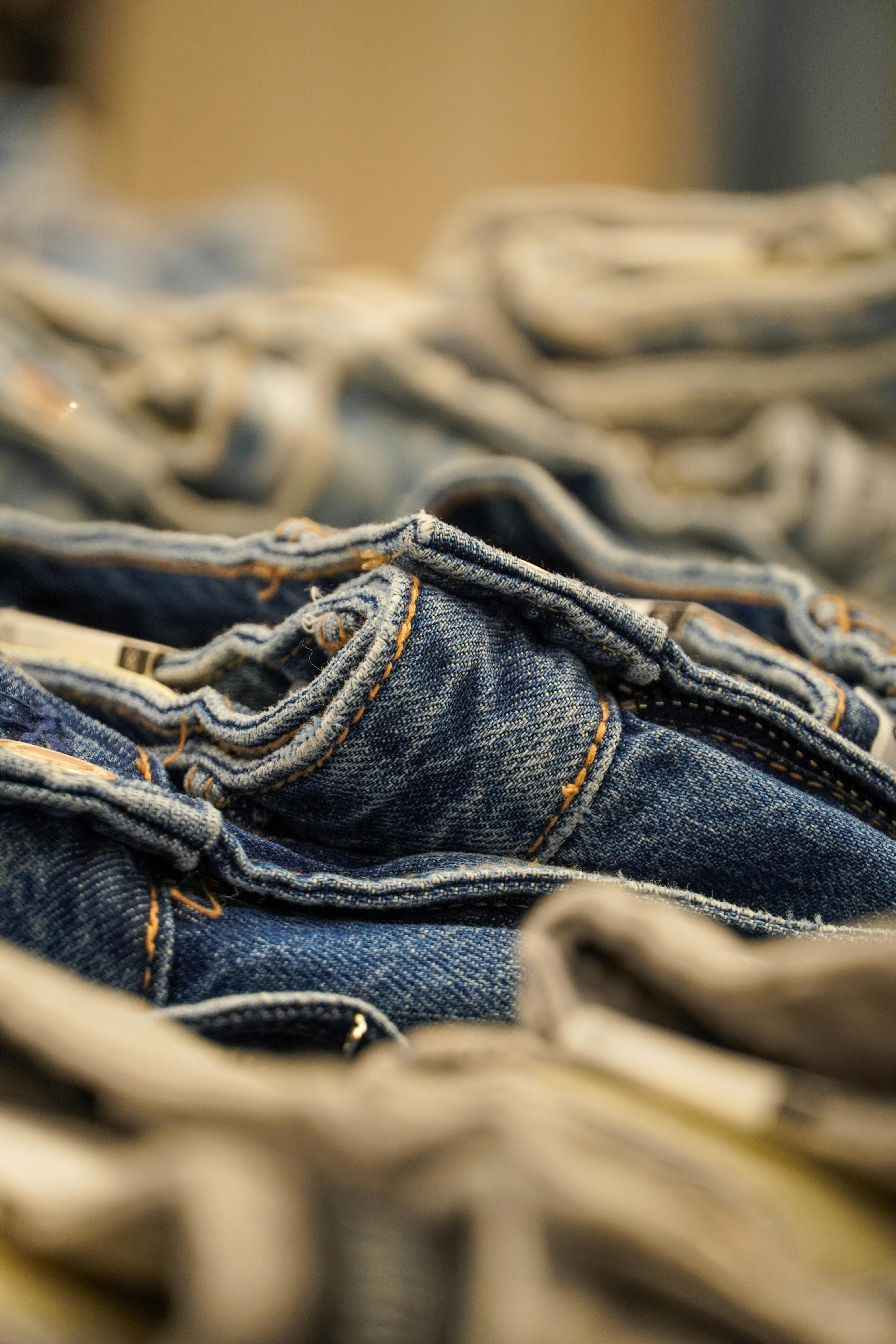 Close-up of Folded Denim Jeans Stack · Free Stock Photo