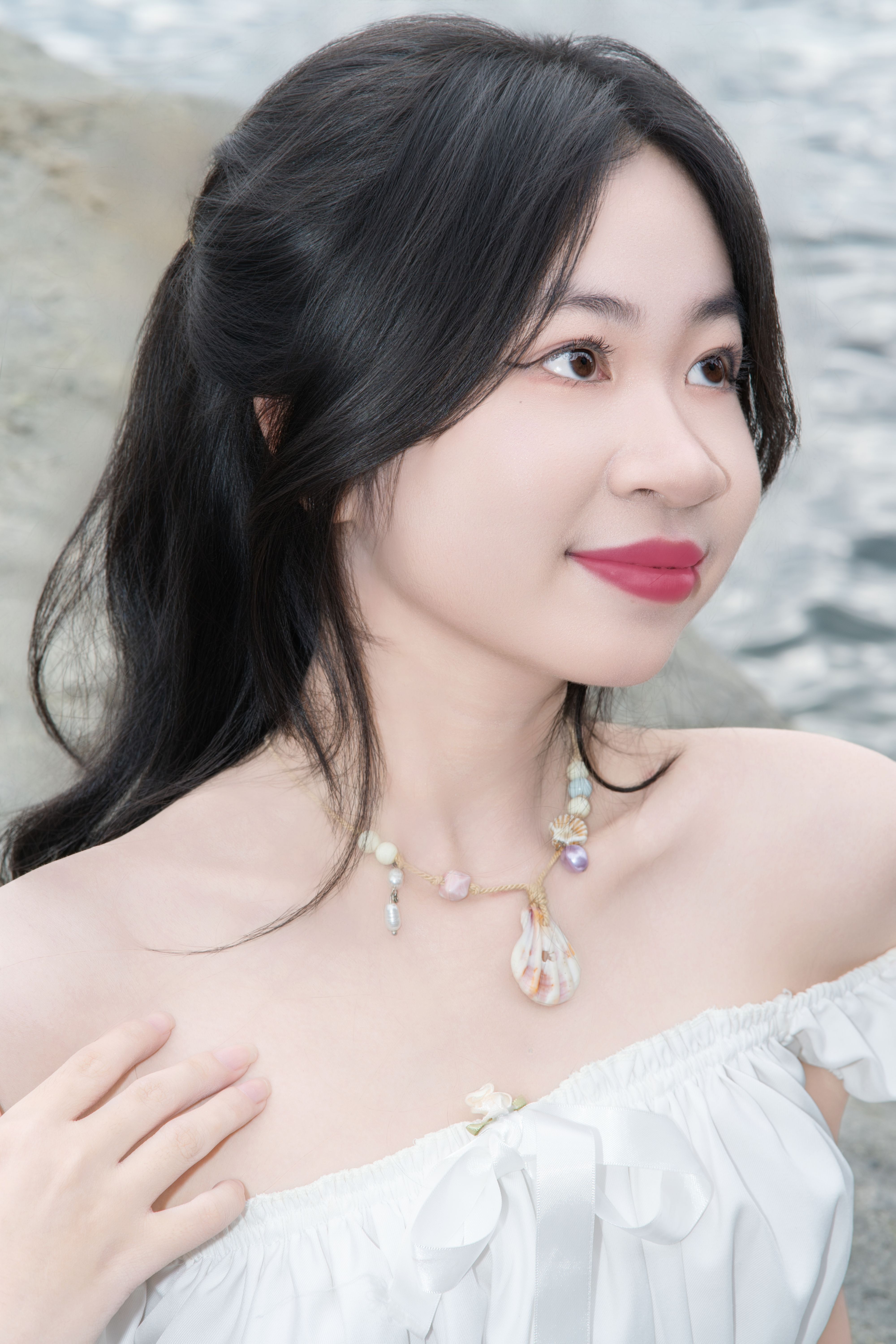 Portrait of a Woman Wearing Sea-Inspired Jewelry · Free Stock Photo