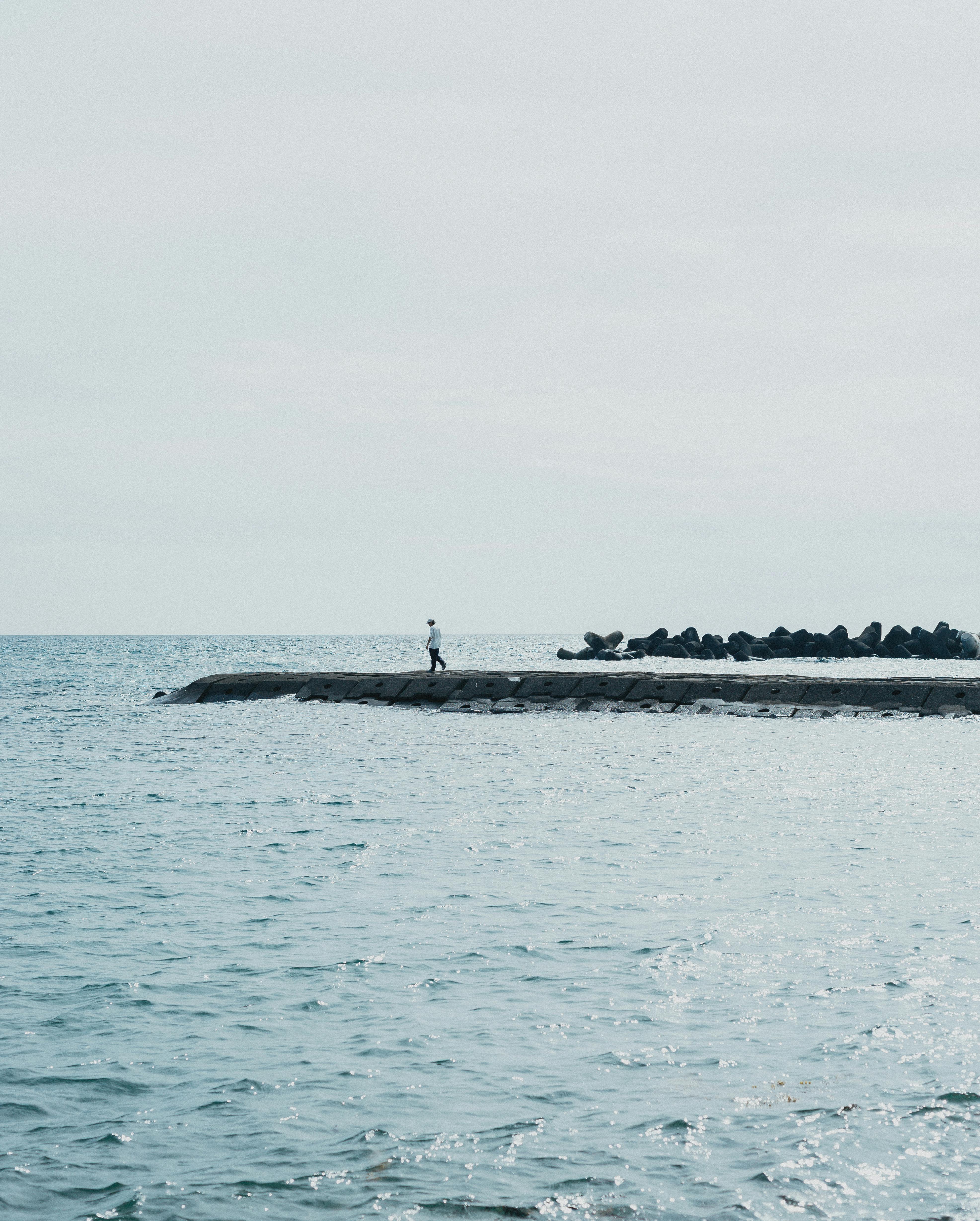 Serene Coastal Walk on a Japanese Pier · Free Stock Photo