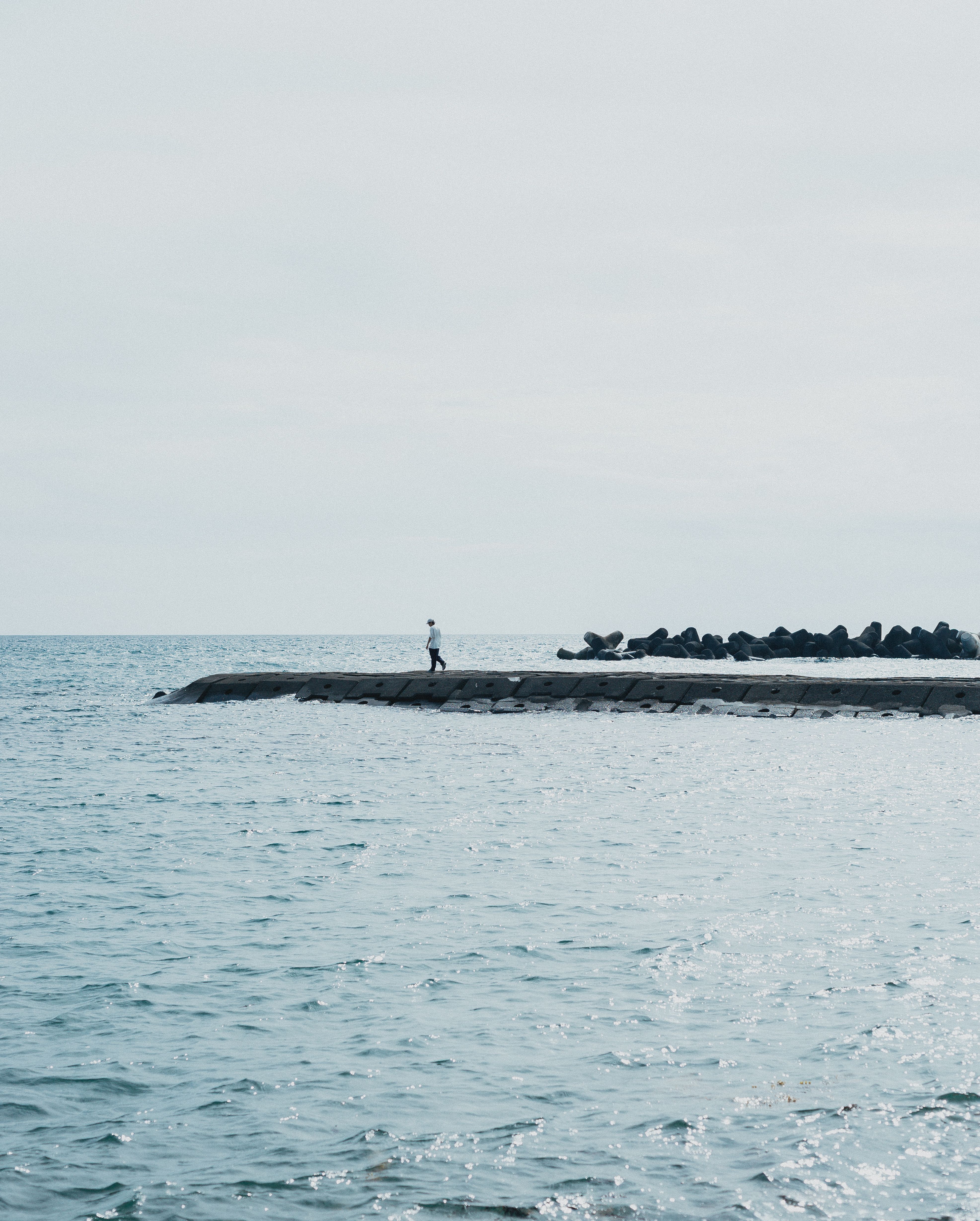 Serene Coastal Walk on a Japanese Pier · Free Stock Photo