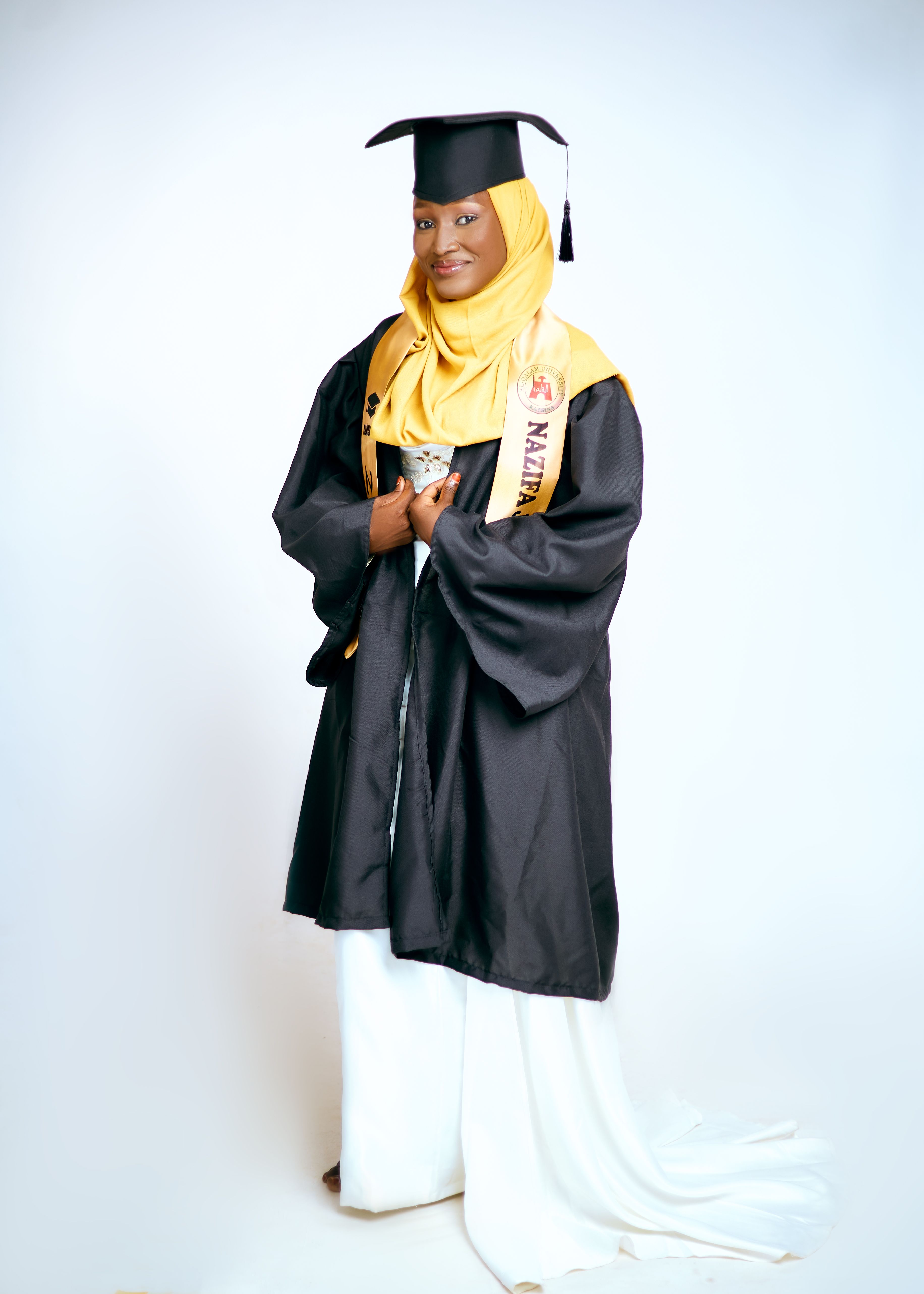 Young Graduate in Academic Gown and Hijab Smiling · Free Stock Photo