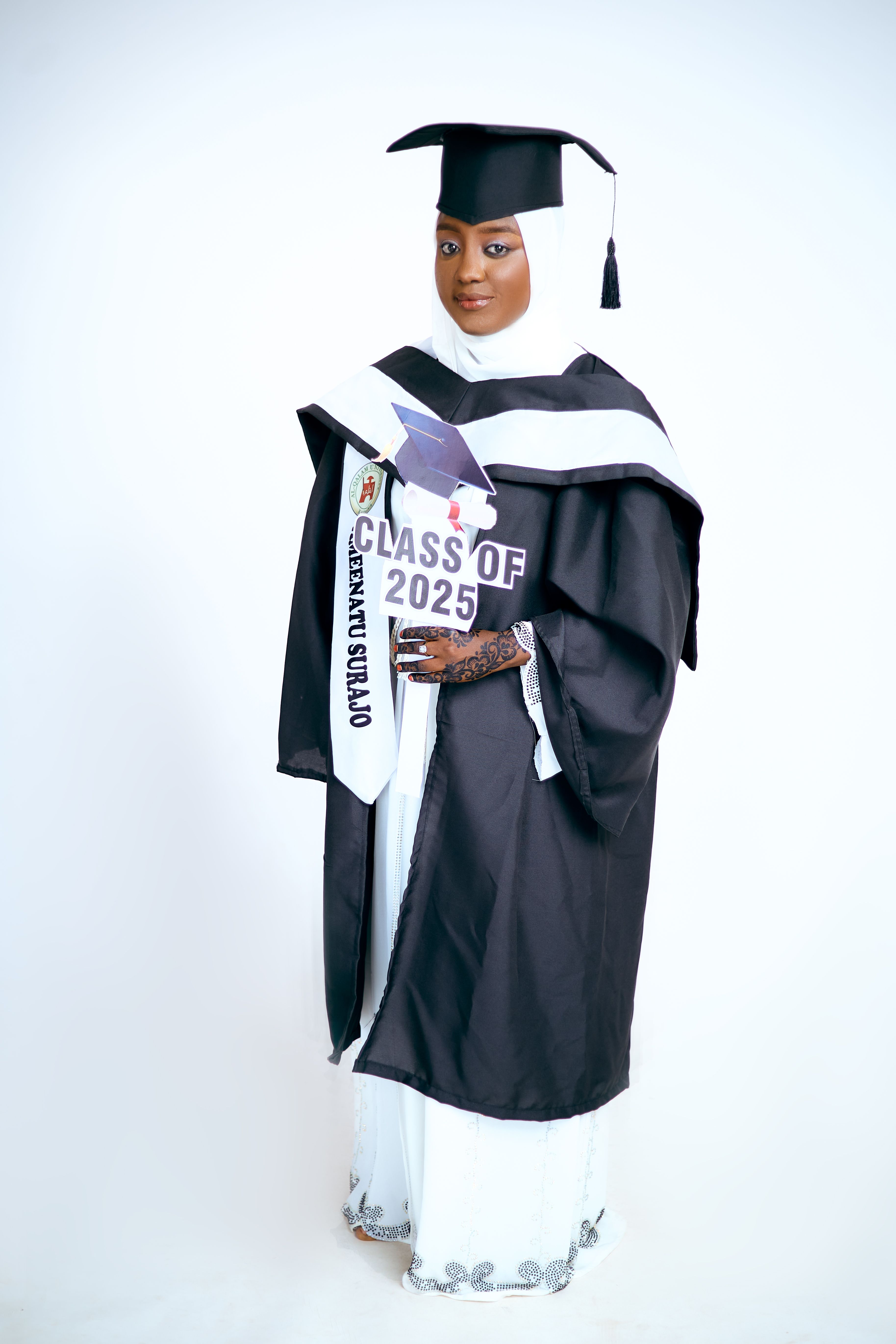 Young Graduate in Academic Gown Celebrating Achievement · Free Stock Photo