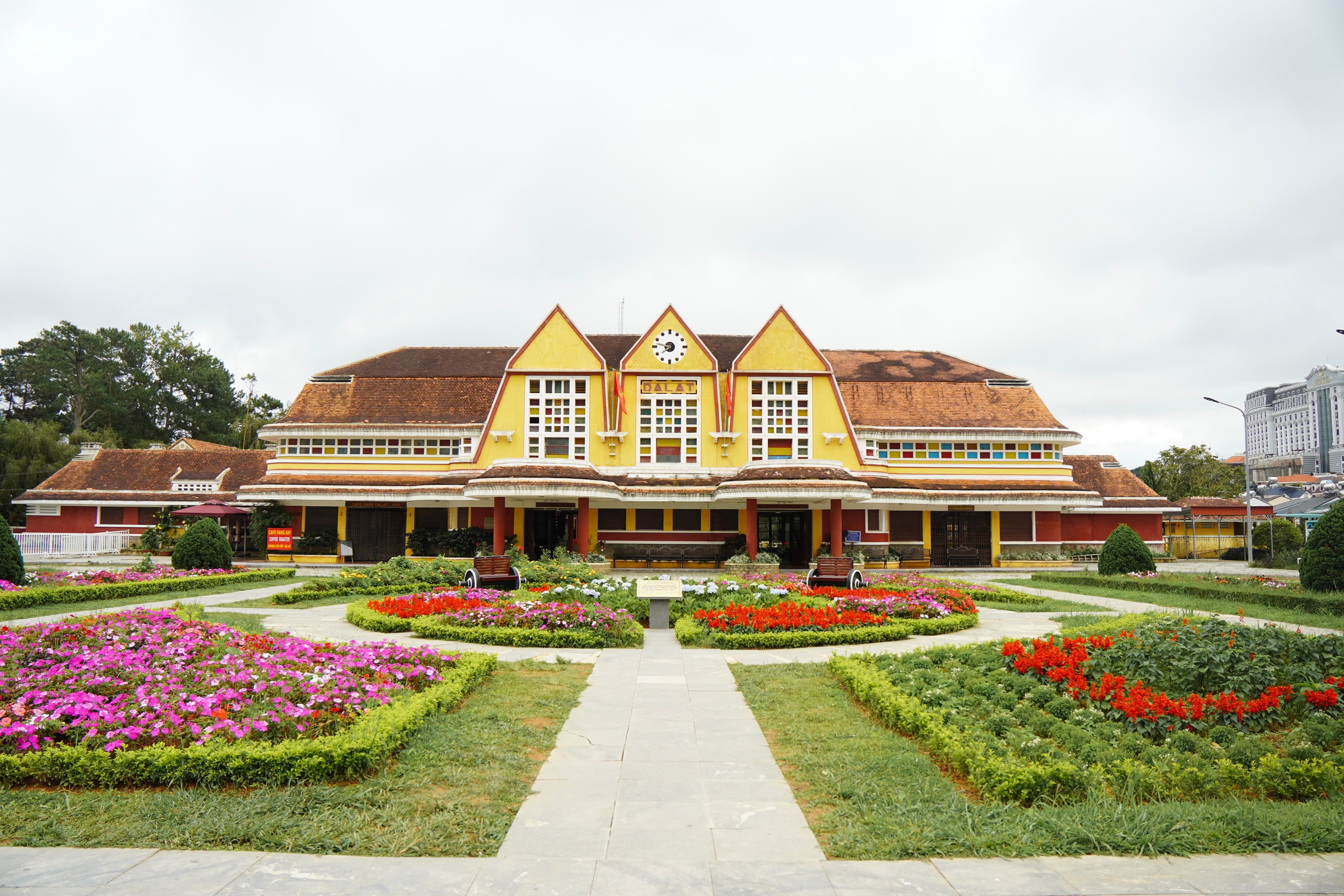Colorful Railway Station with Vibrant Gardens · Free Stock Photo