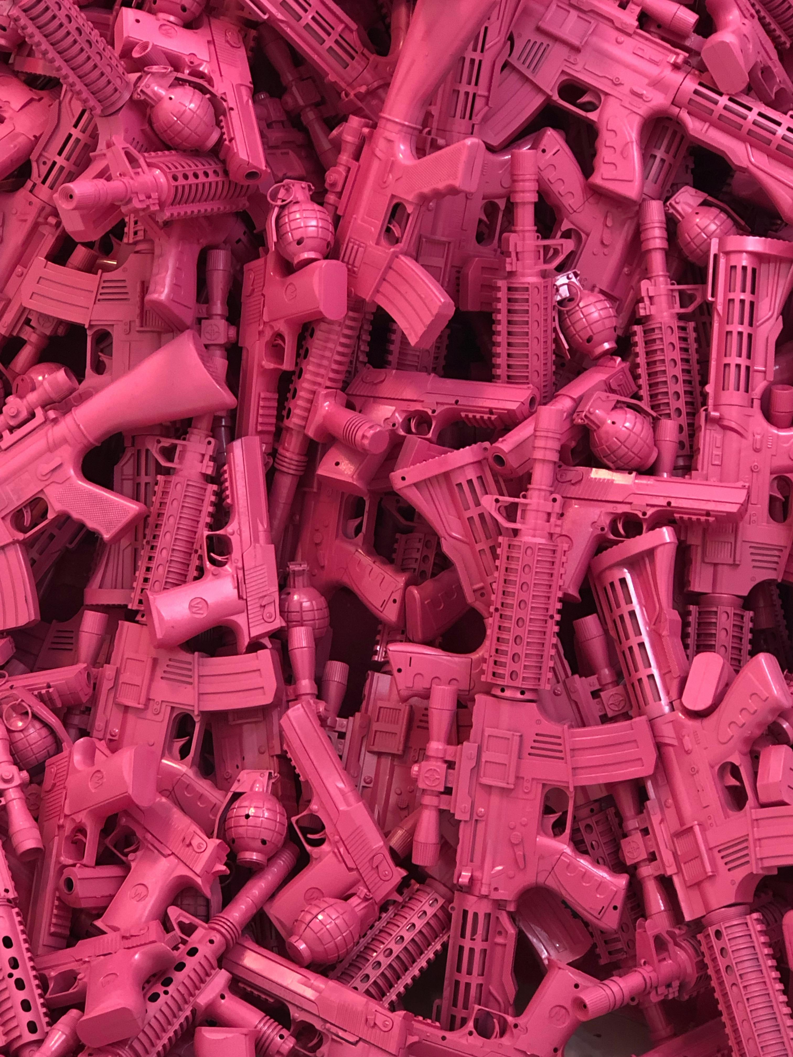Vibrant Neon Pink Toy Guns Display · Free Stock Photo