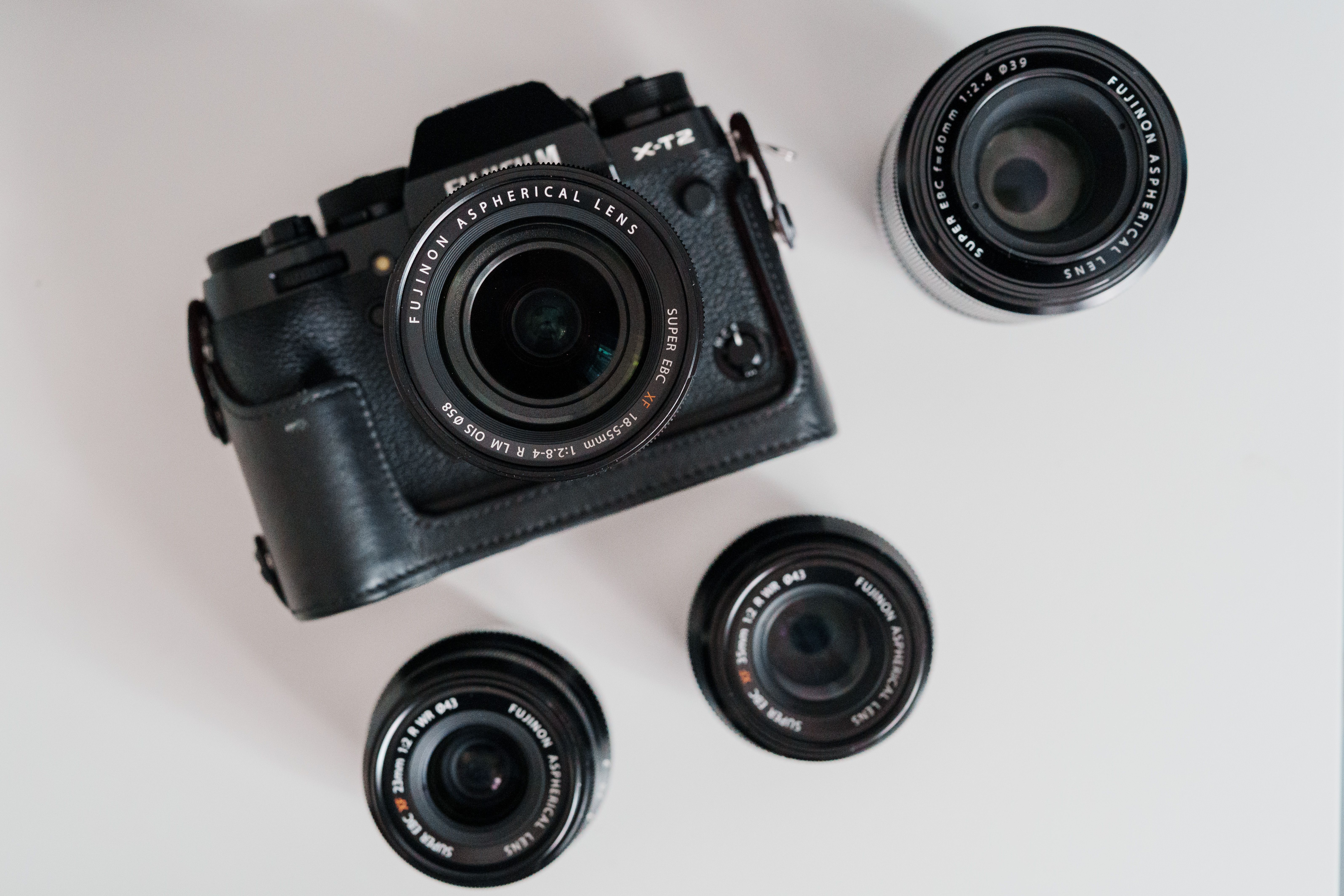 Flat Lay of Camera and Lenses on White Background · Free Stock Photo
