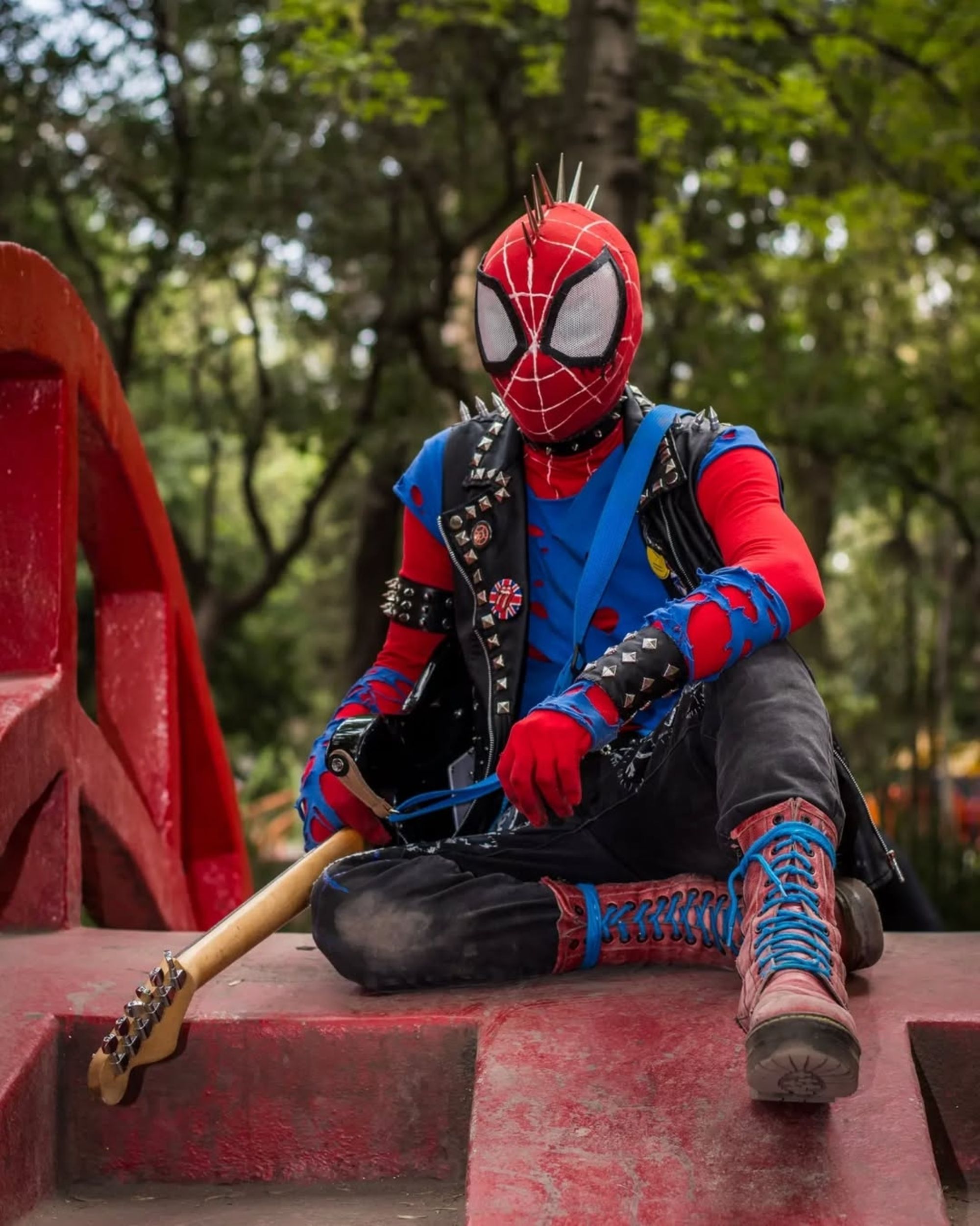 Vibrant Punk Spider Character Playing Guitar Outdoors · Free Stock Photo