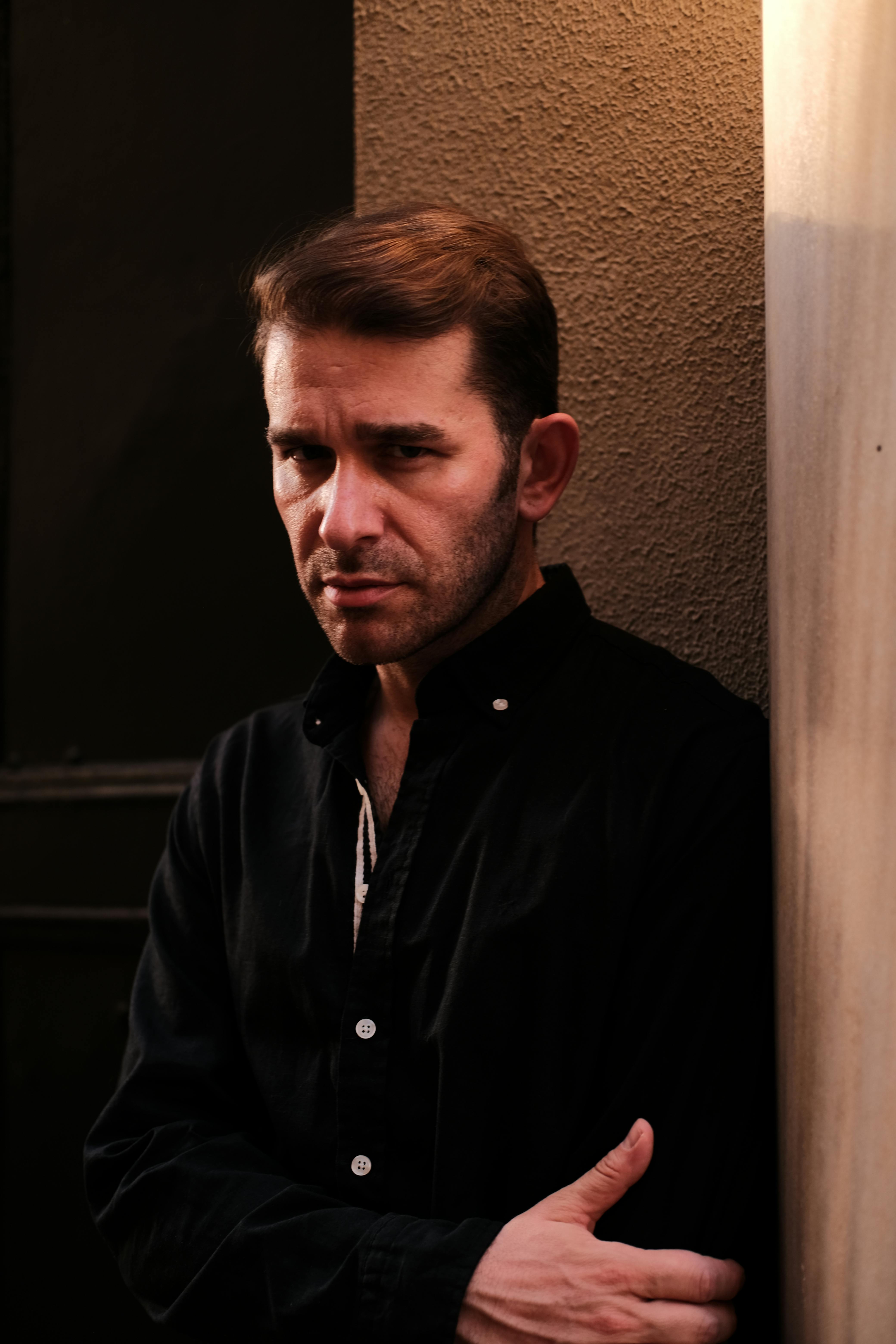 Moody Portrait of a Man in Shadow · Free Stock Photo