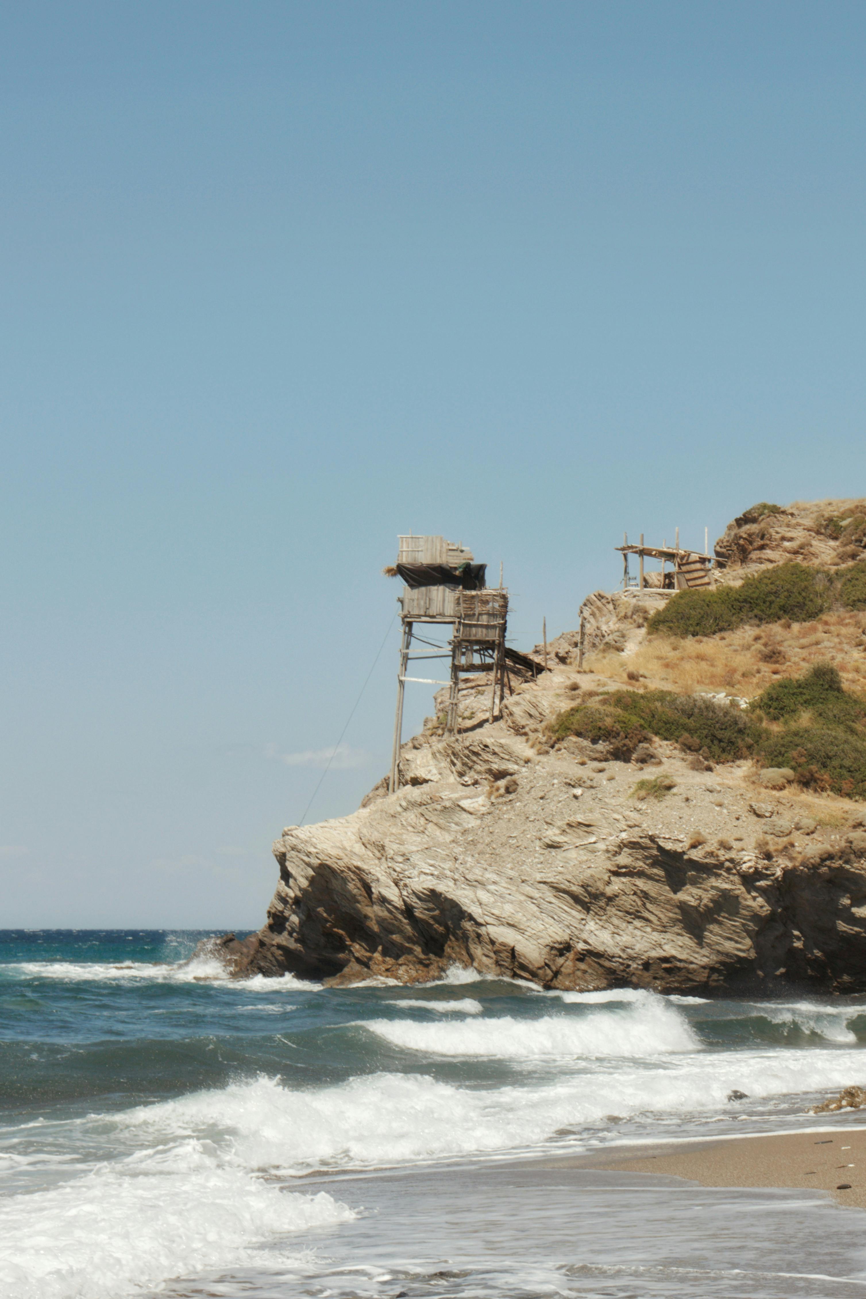 Rustic Coastal Watchtower on Rocky Shore · Free Stock Photo