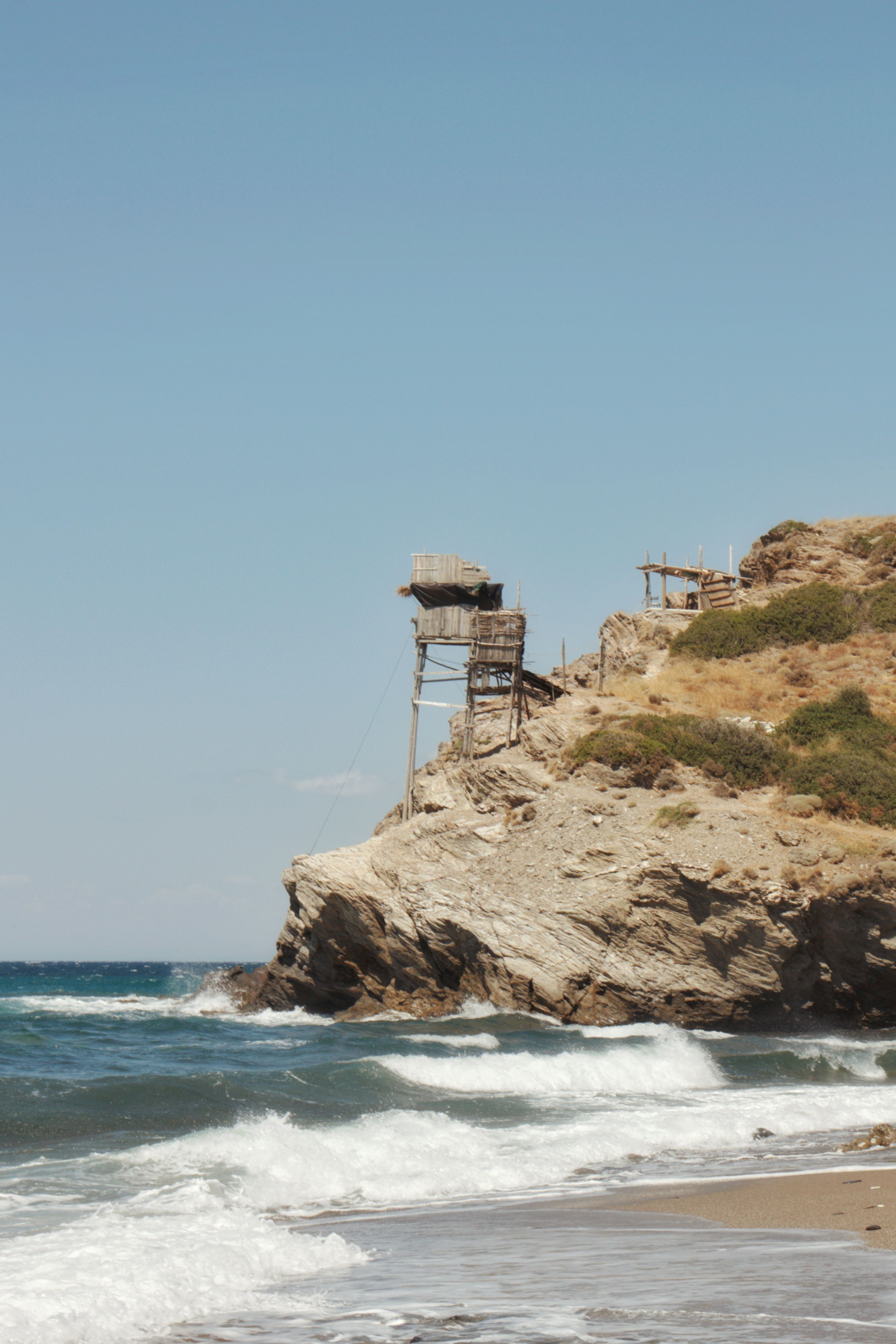 Rustic Coastal Watchtower on Rocky Shore · Free Stock Photo