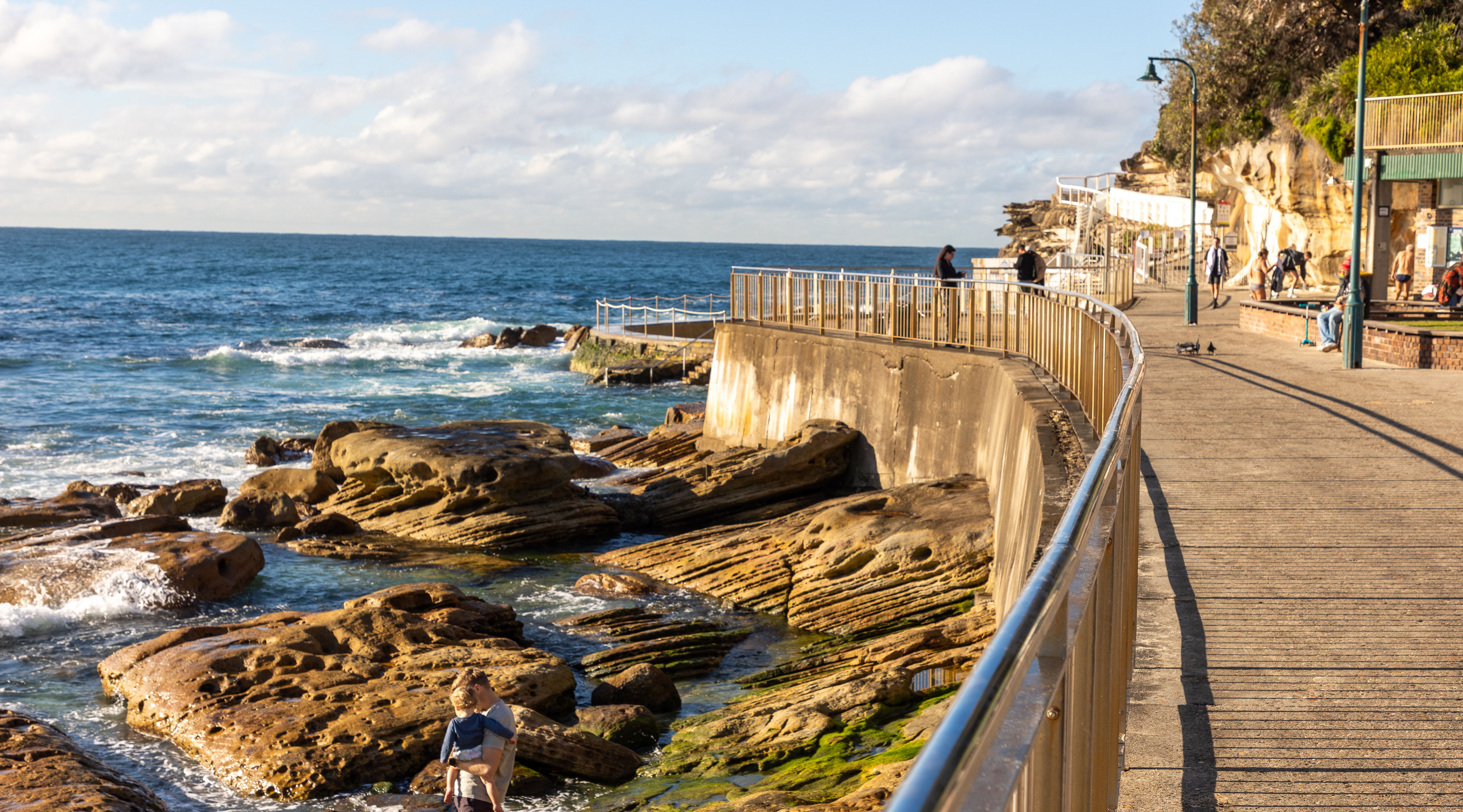 Scenic Coastal Walkway with Rocky Shoreline · Free Stock Photo