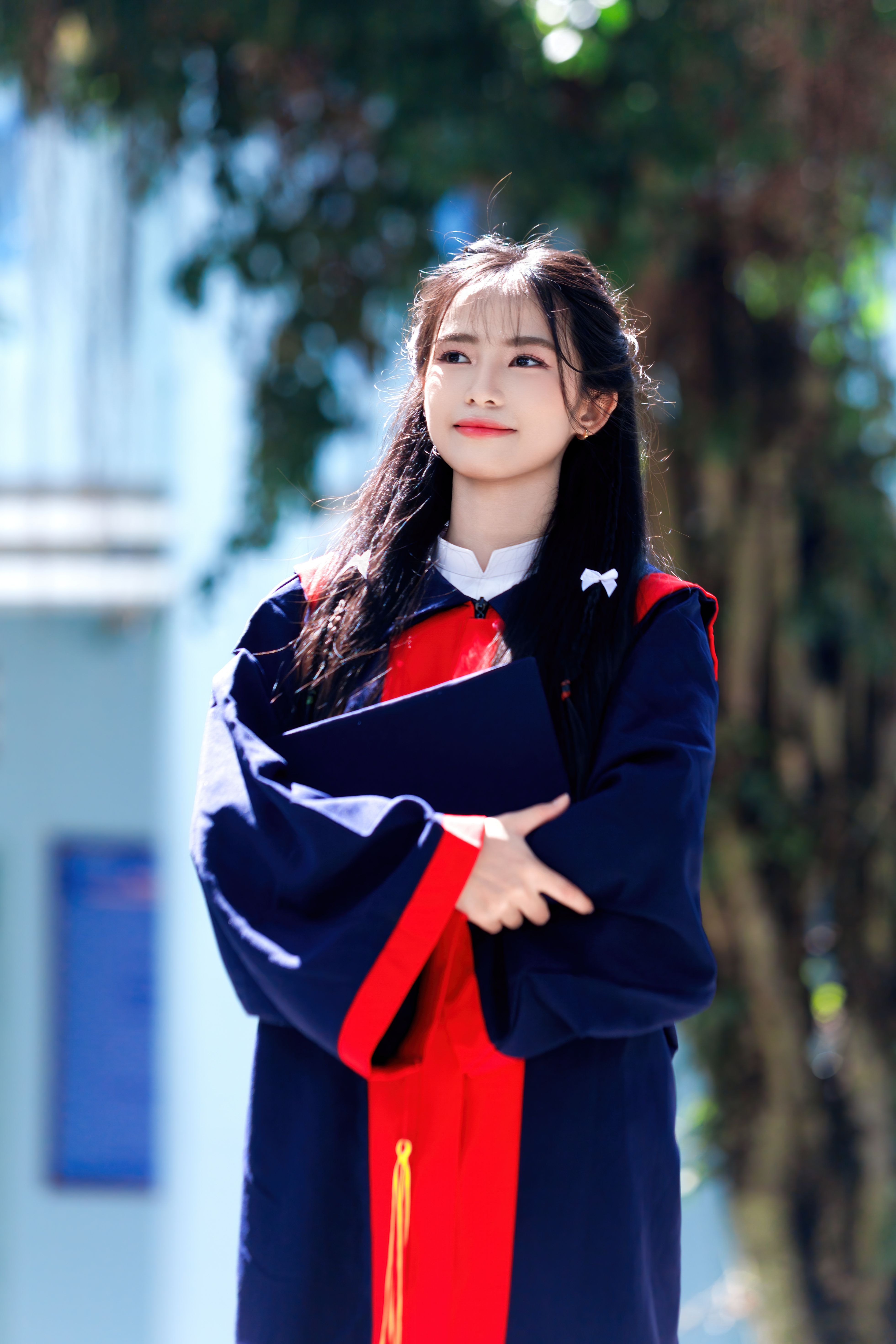 Young Graduate Smiling Outdoors in Cap and Gown · Free Stock Photo