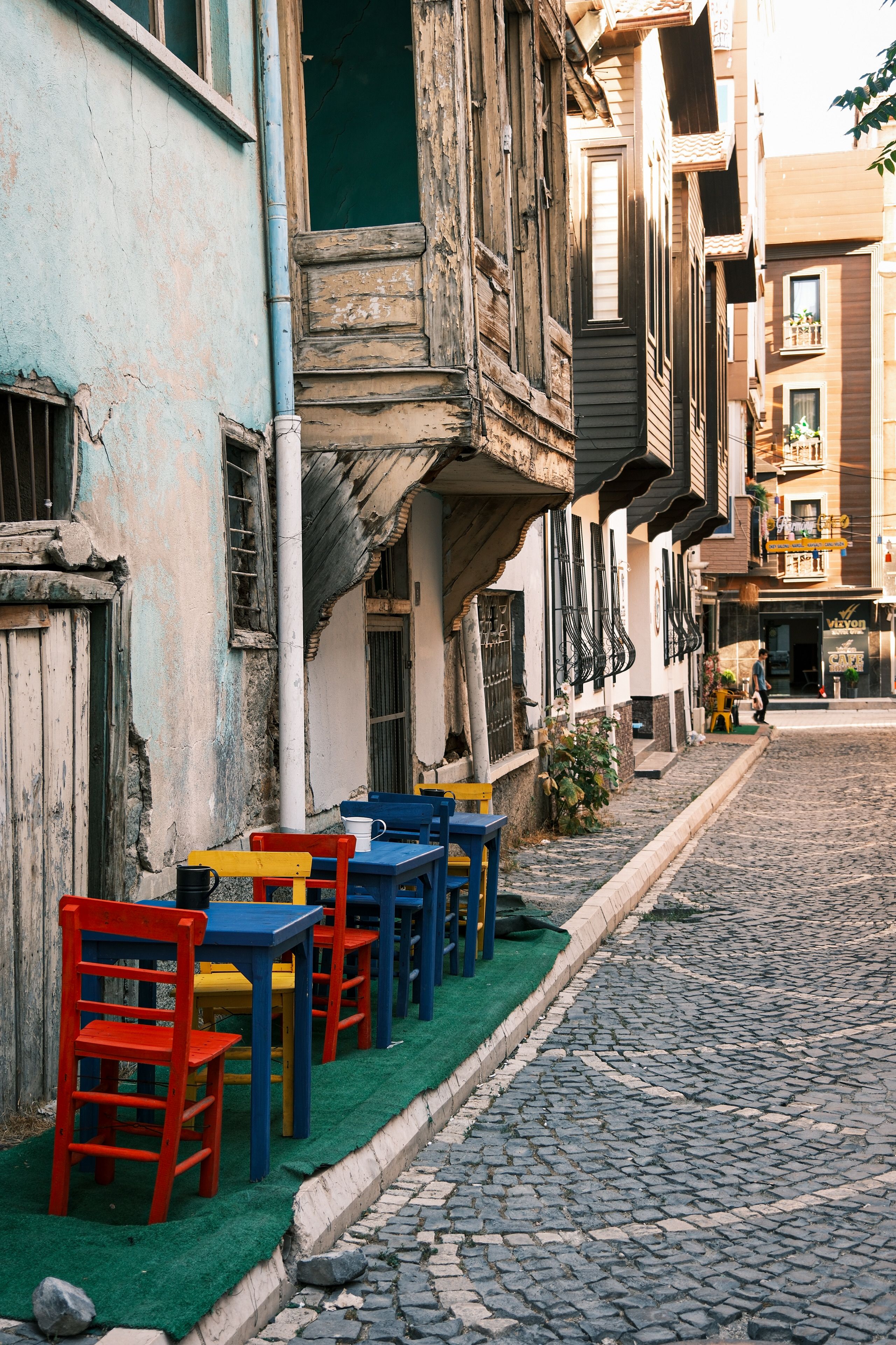 Colorful Chairs on Cobblestone Street at Daytime · Free Stock Photo