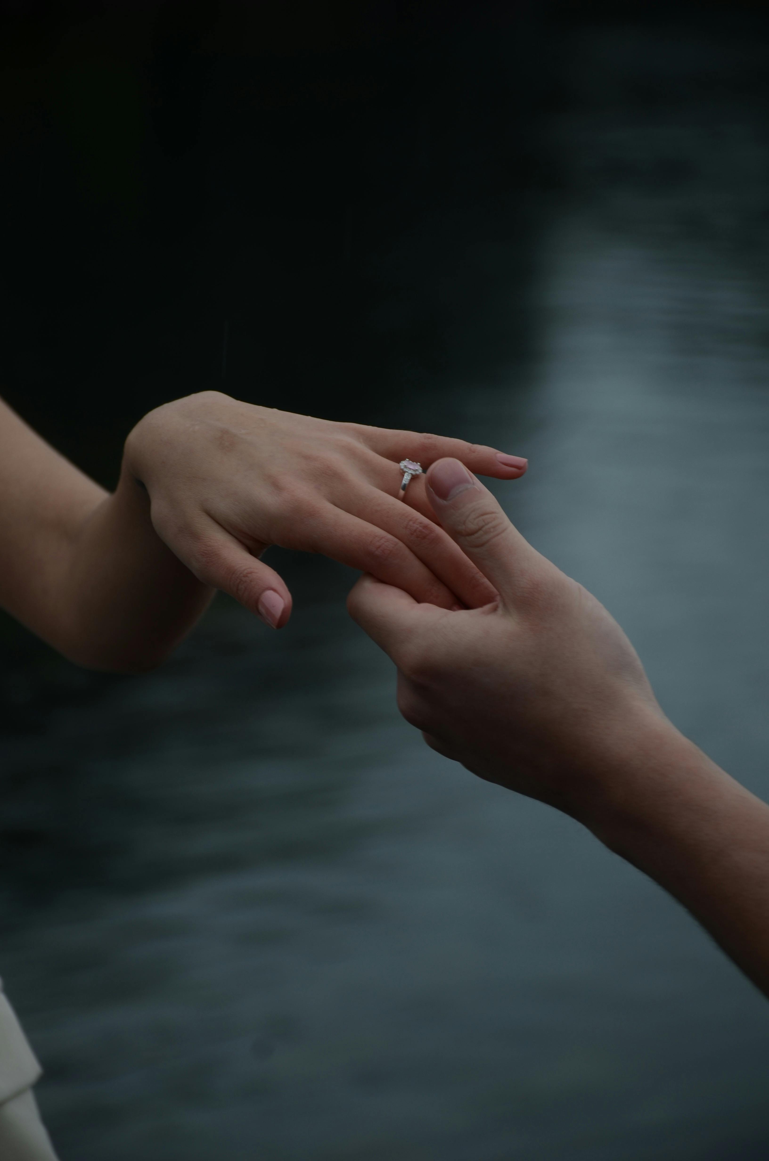 Romantic Engagement Ring Exchange Near Water · Free Stock Photo