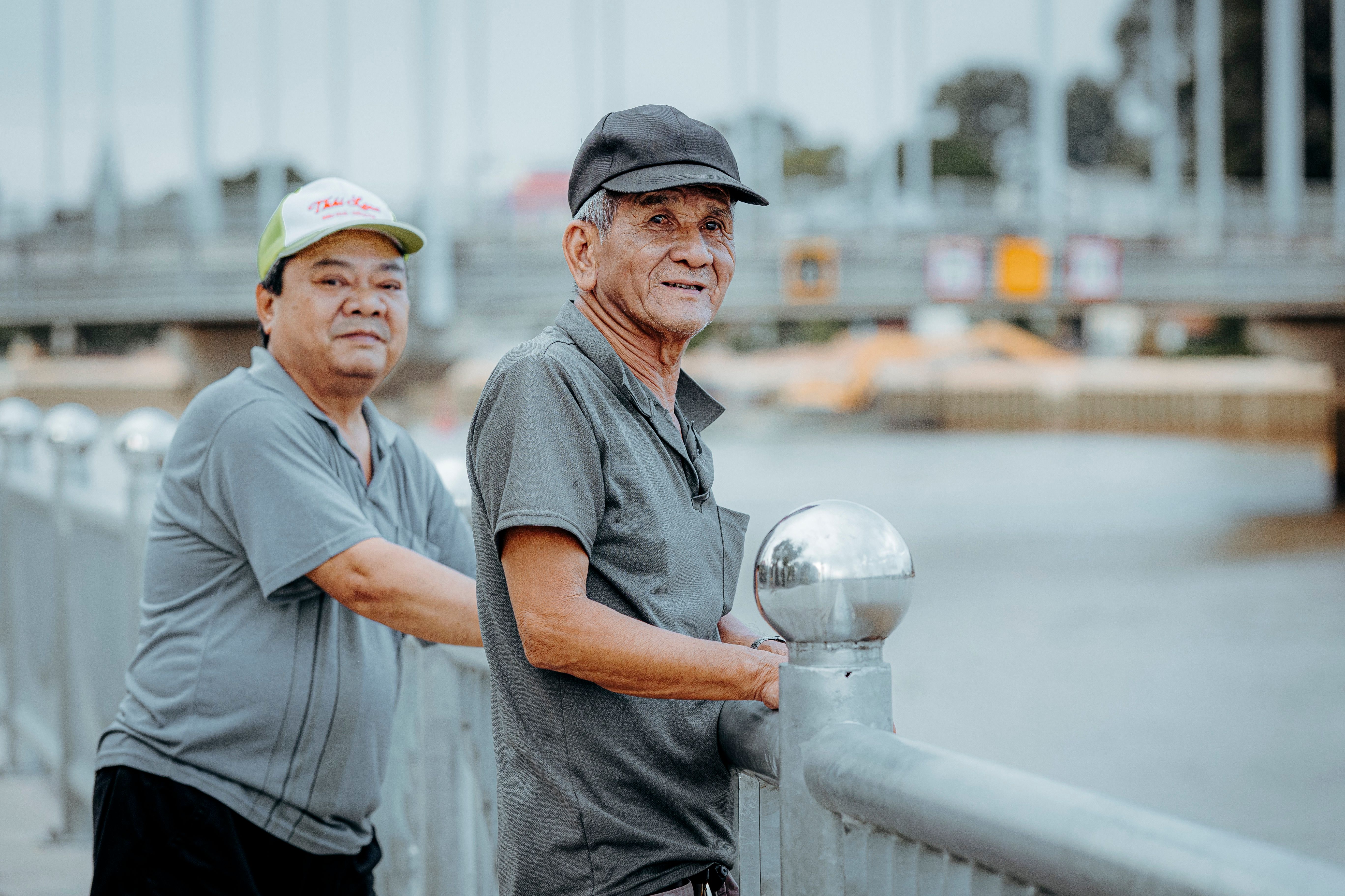Senior Men Enjoying Riverside Stroll · Free Stock Photo