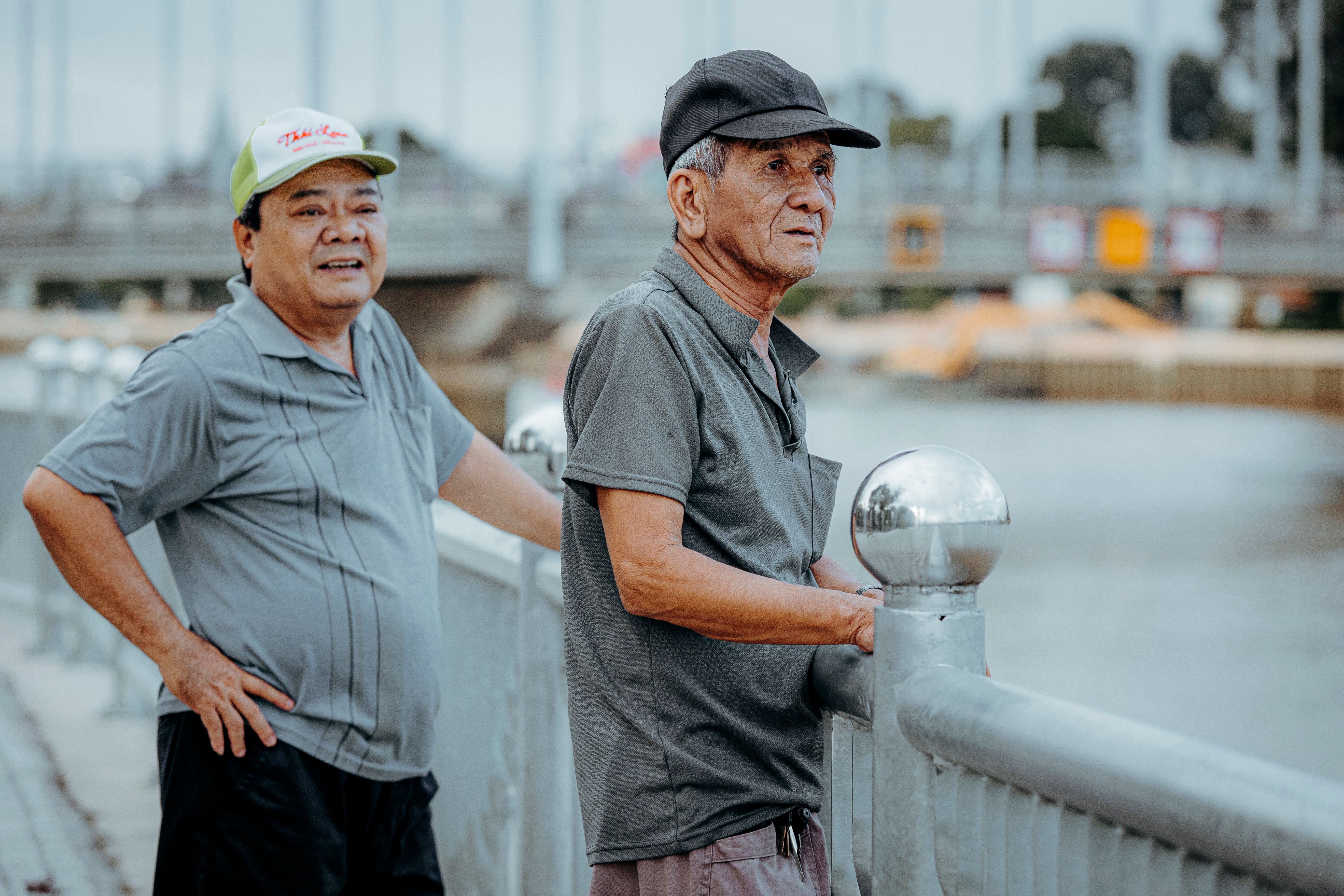 Two Senior Men Enjoy Riverside View Outdoors · Free Stock Photo