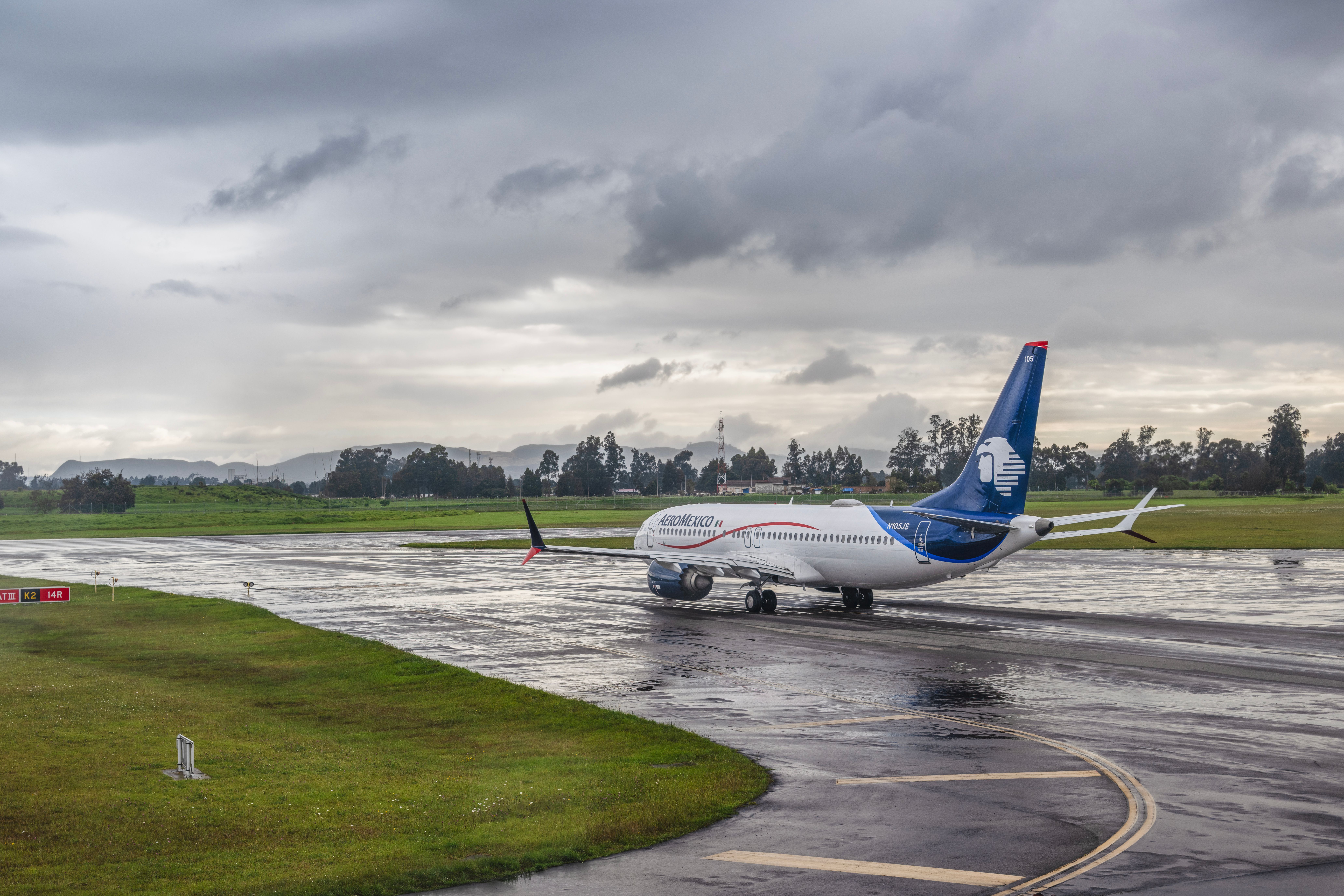 Commercial Airplane on Wet Runway at Airport · Free Stock Photo