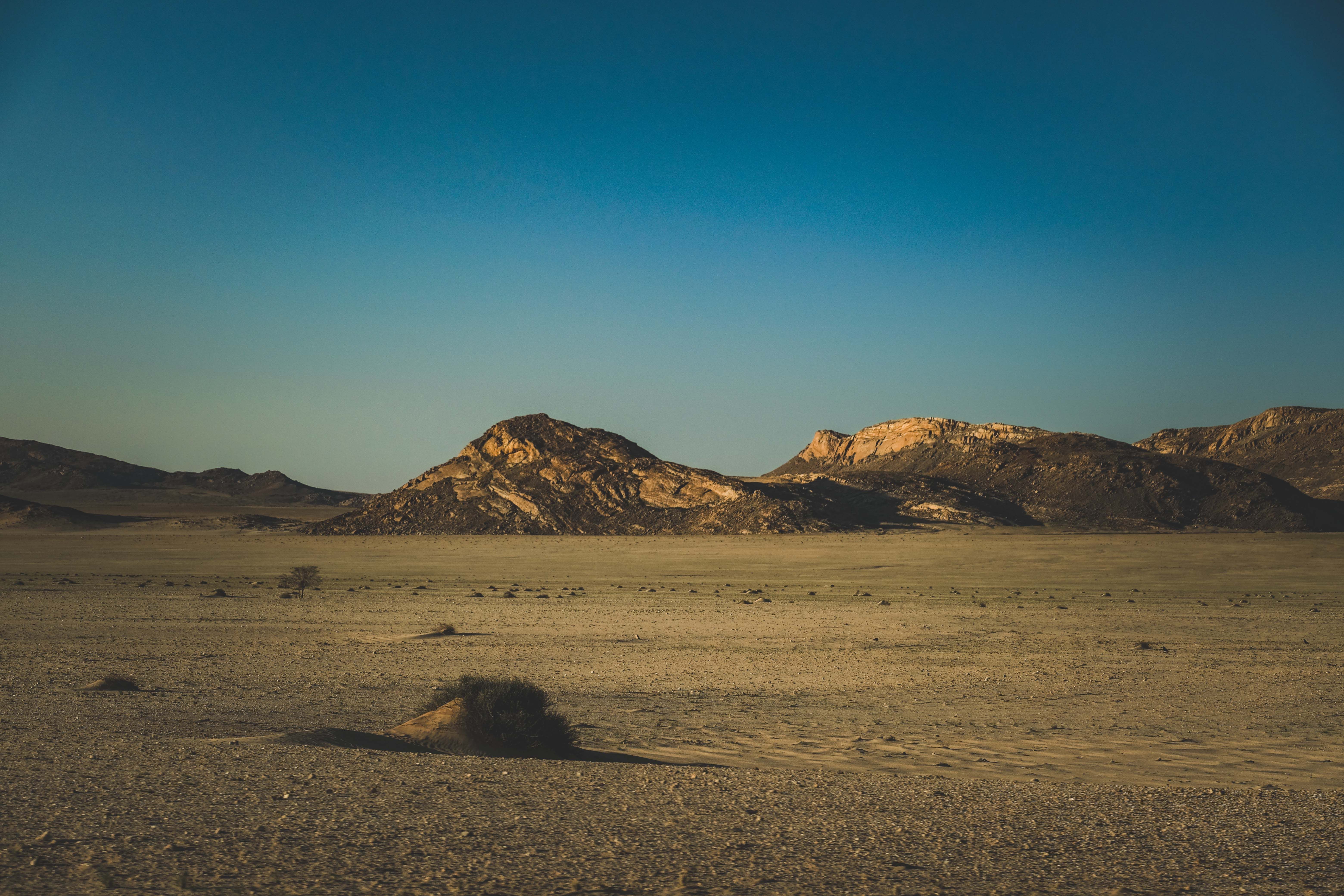 Vast Desert Landscape with Distant Hills · Free Stock Photo