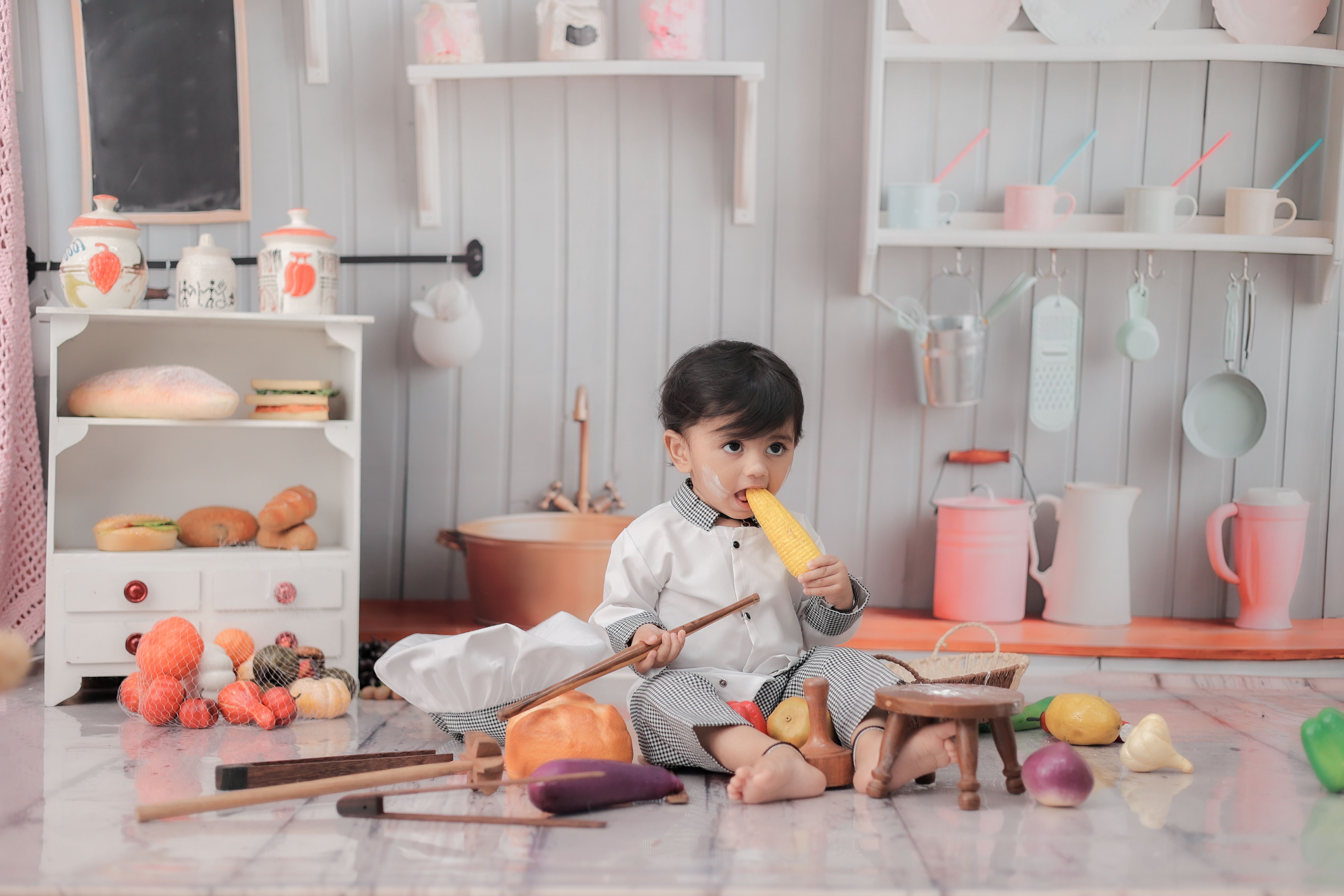 Adorable Child Playing in Kitchen Setting · Free Stock Photo